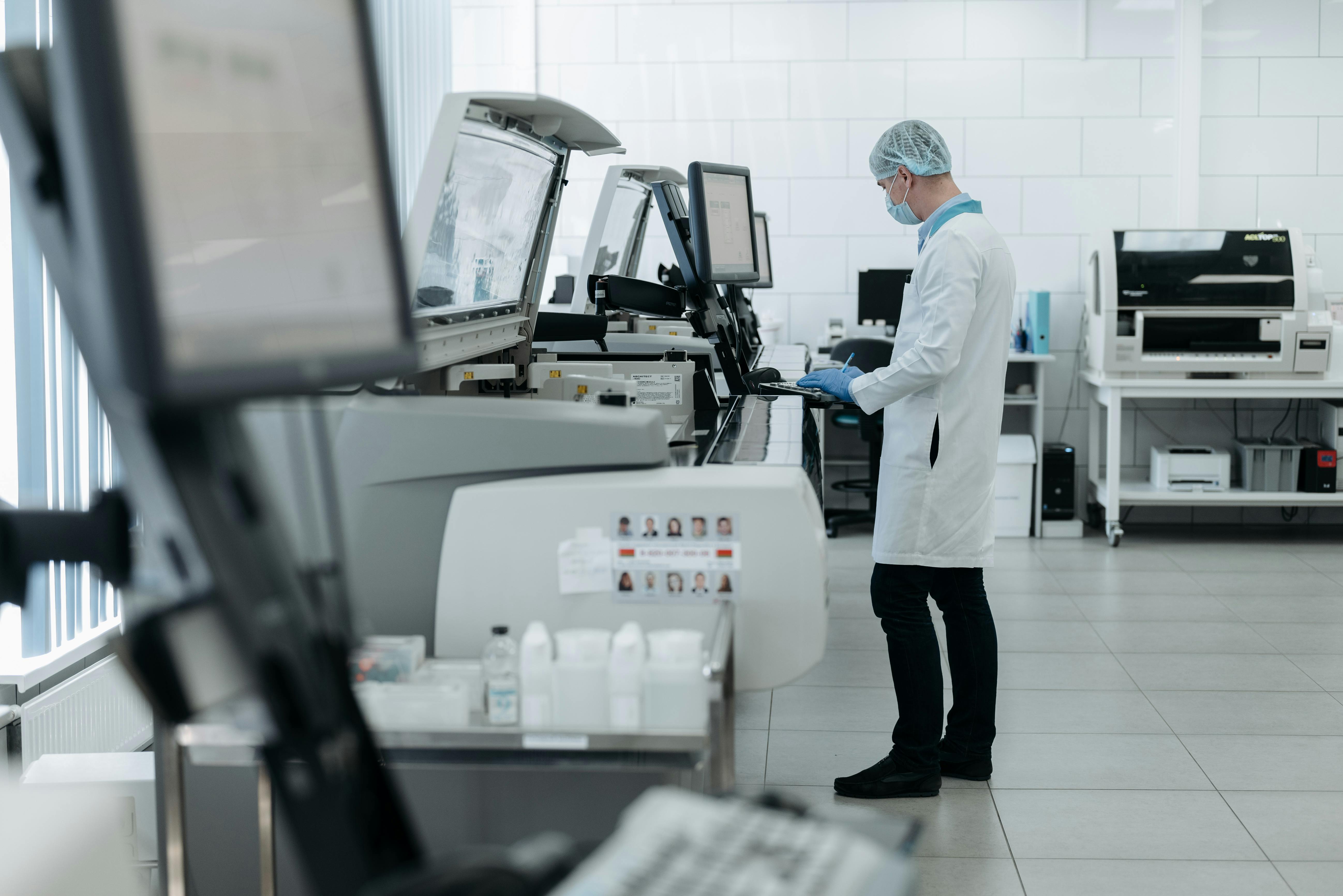 A Man in Lab Gown in a Laboratory · Free Stock Photo