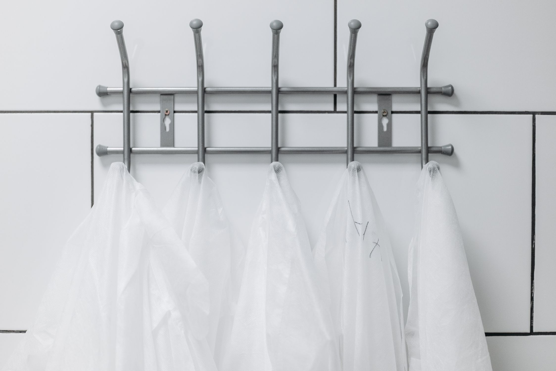 Lab Coats Hanging on Metal Hanger · Free Stock Photo