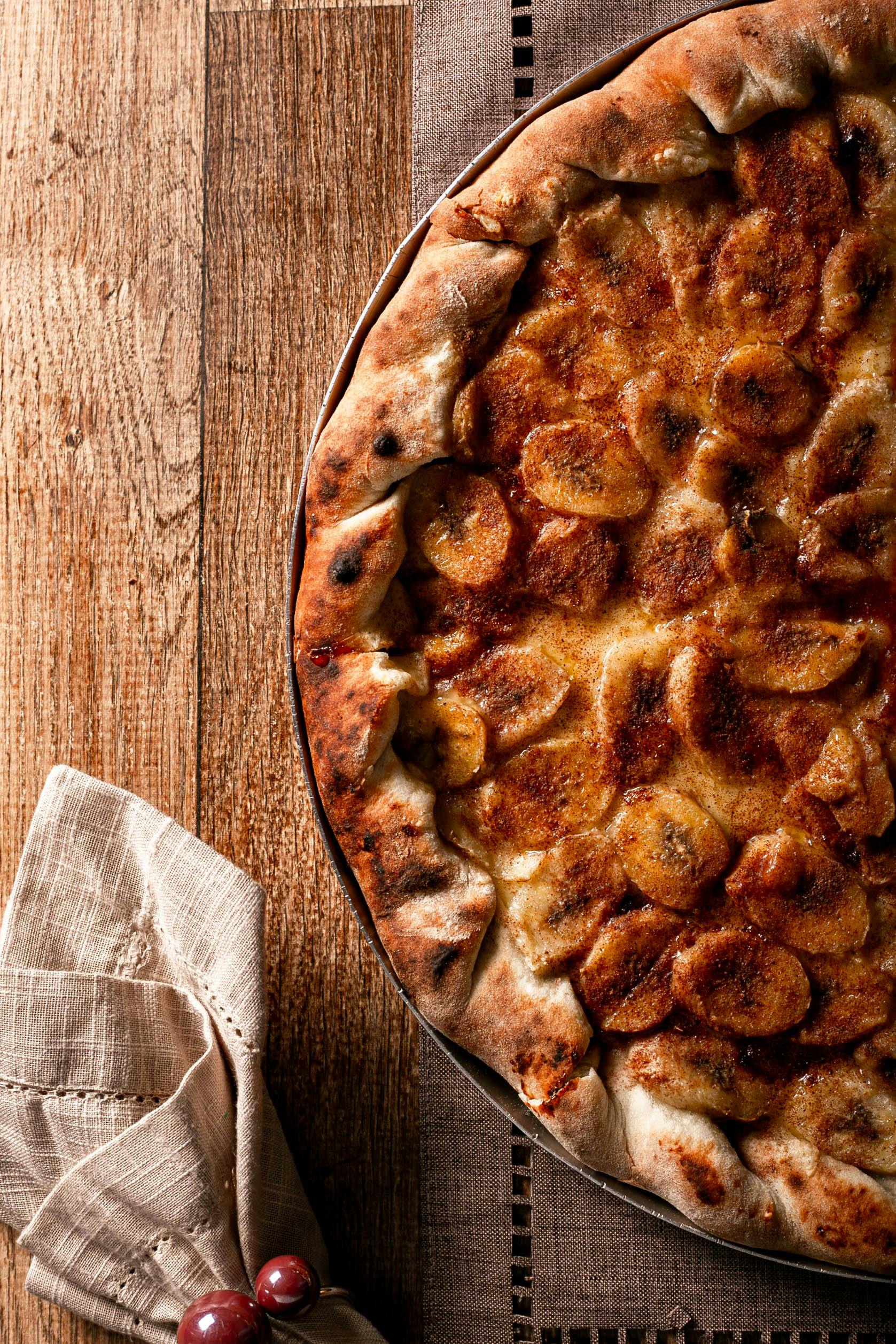 Hand Holding a Pizza Slice · Free Stock Photo