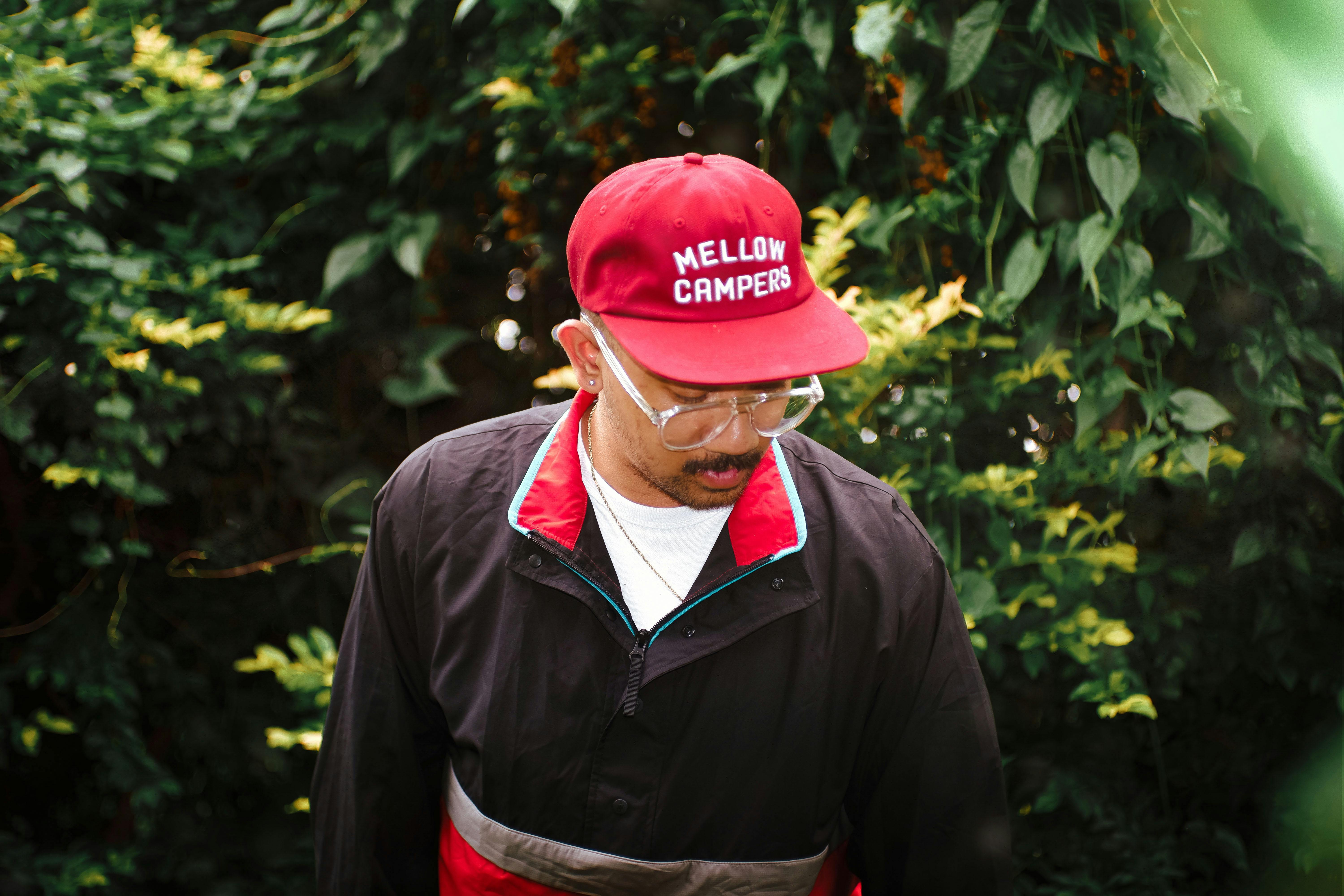 Close-Up Photo of a Man in a Red Cap Looking Down · Free Stock Photo