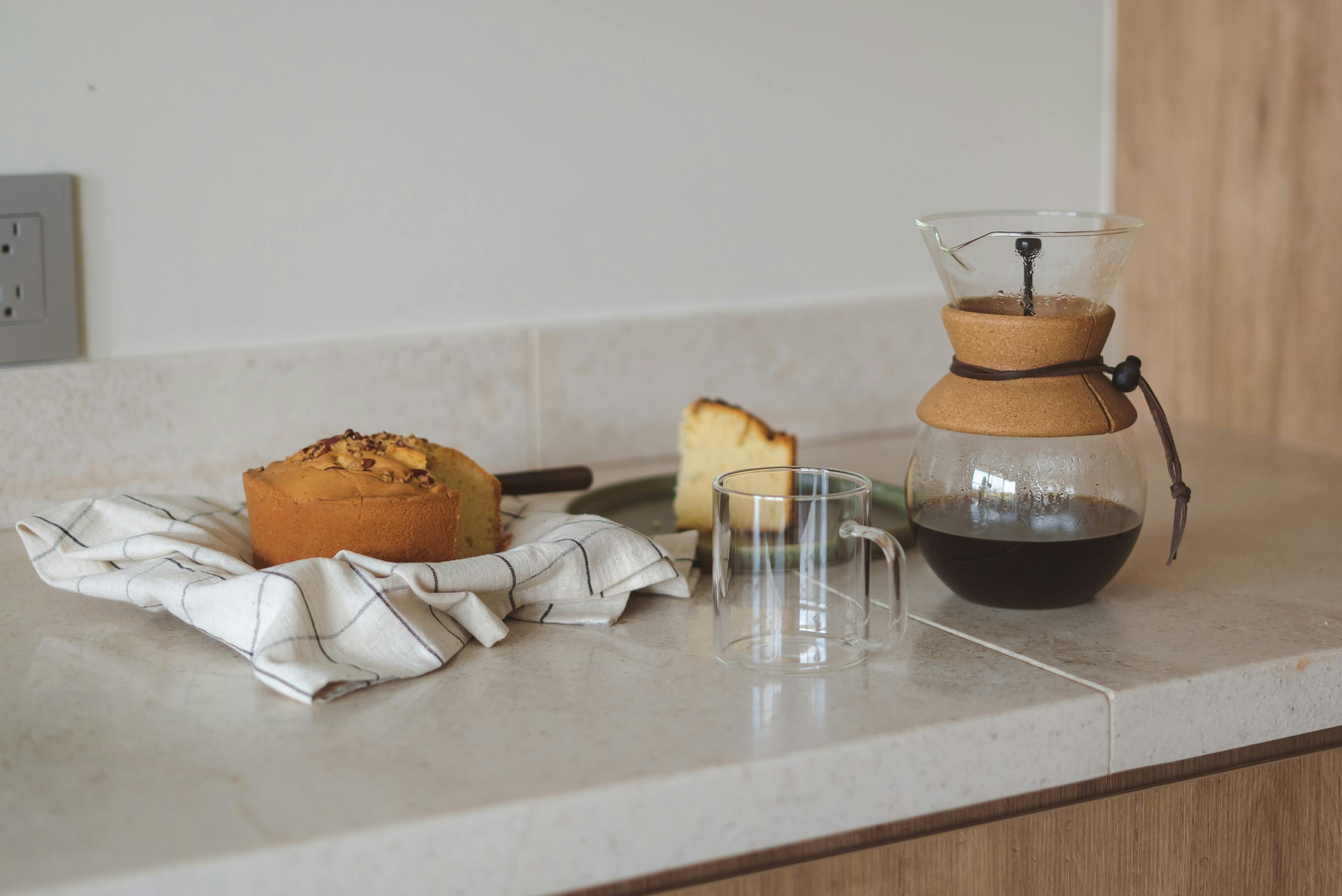 Drip Coffee Pitcher and a Cake on the Kitchen Counter · Free Stock Photo