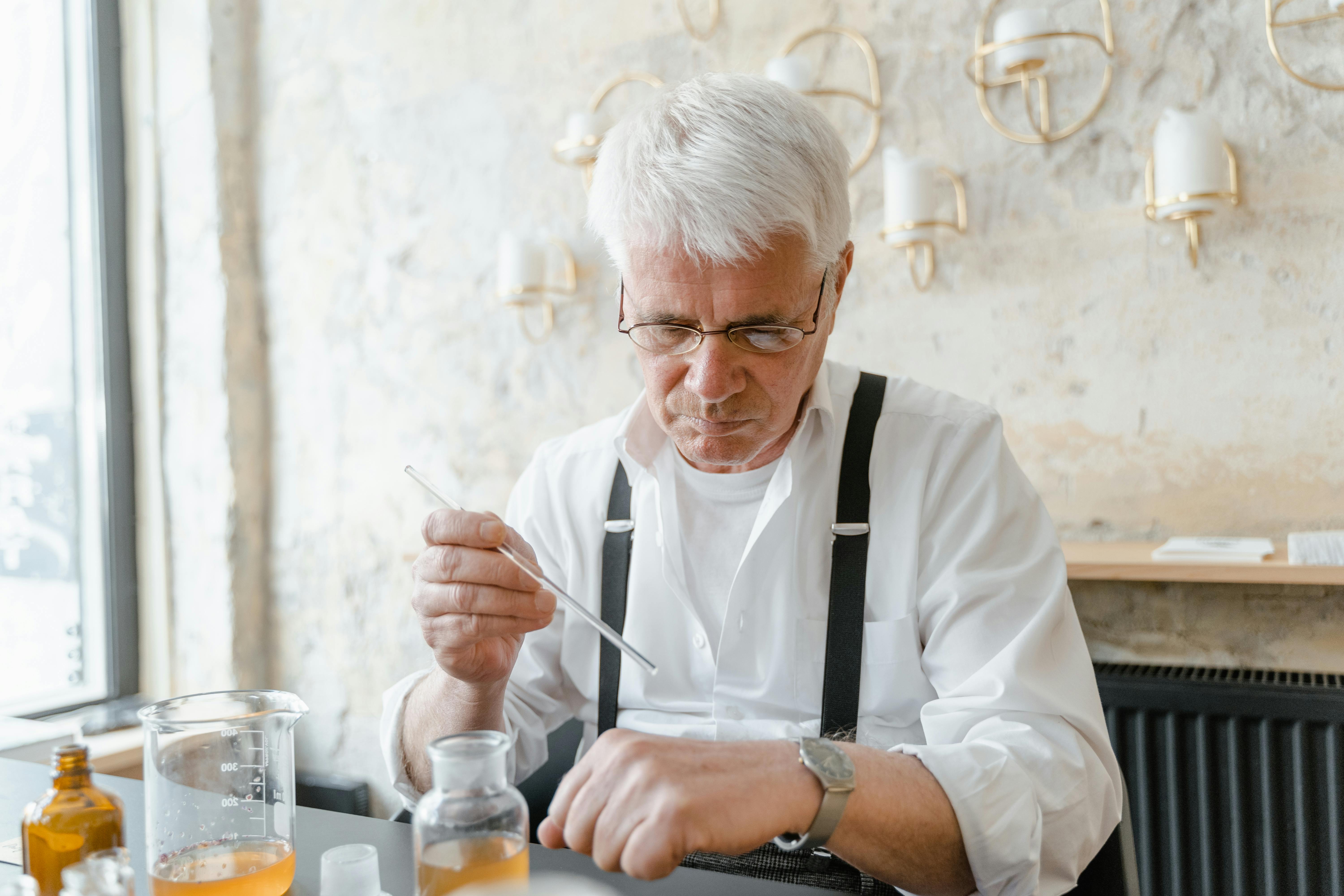 Elderly Man Testing Liquid on Hand · Free Stock Photo