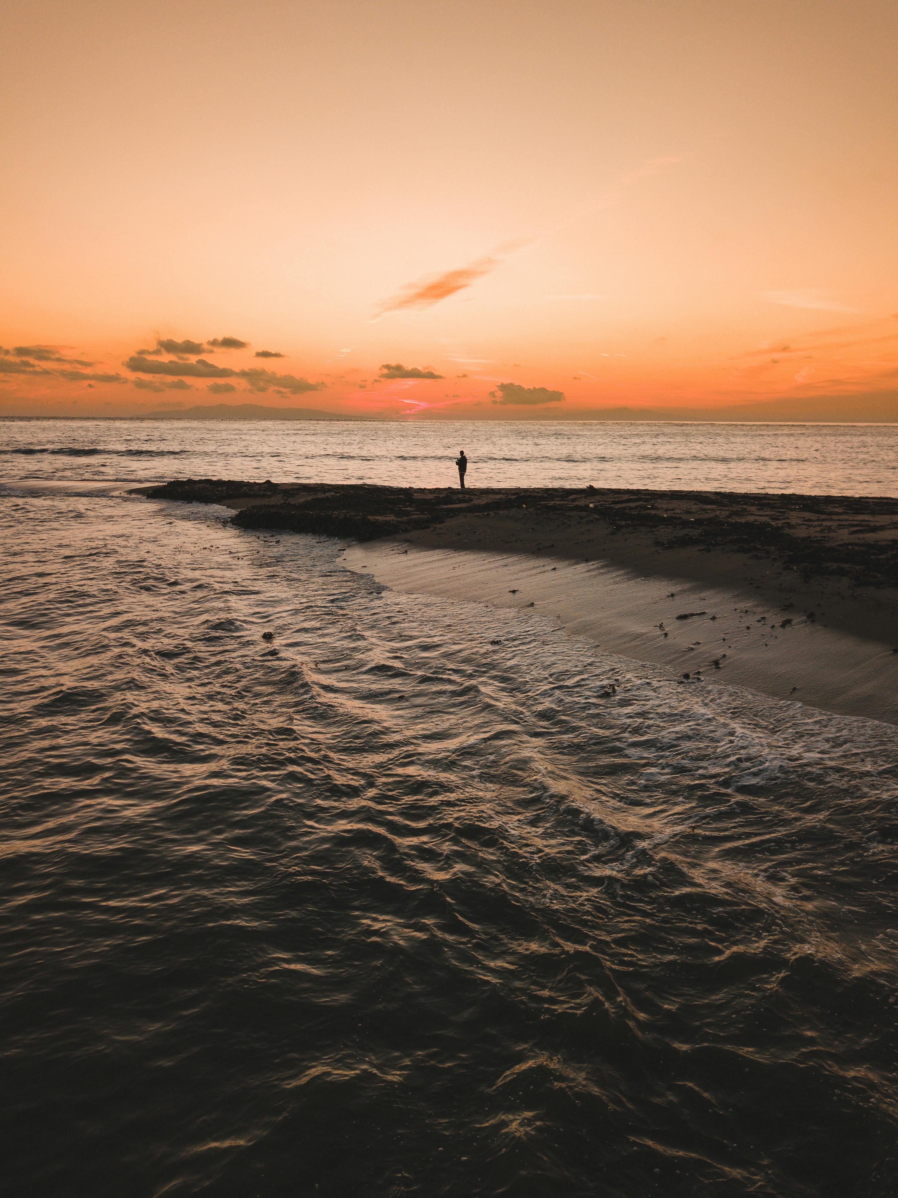 Person on Sea Shore at Sunset · Free Stock Photo
