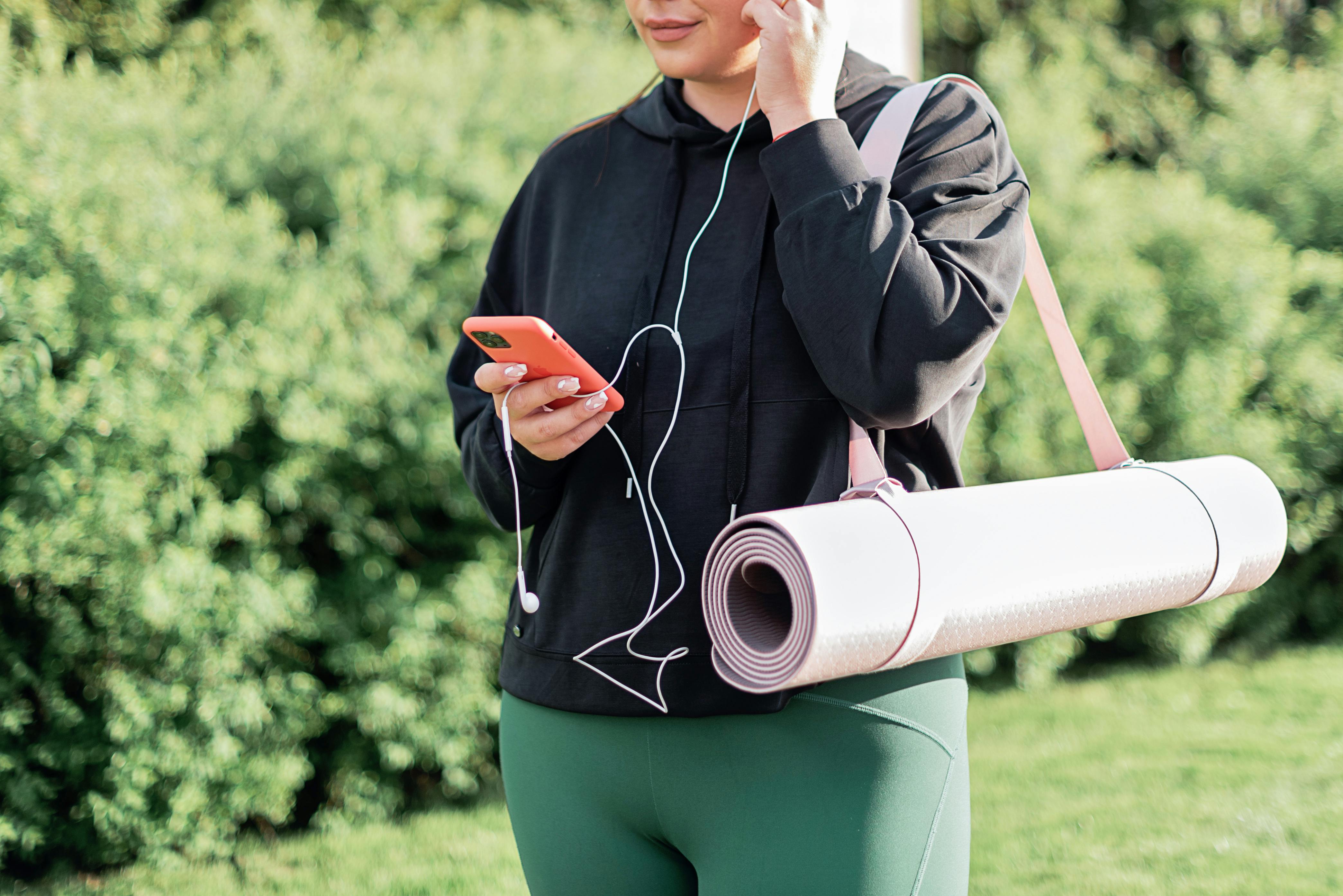 Woman Using a Cellphone and Earphones · Free Stock Photo