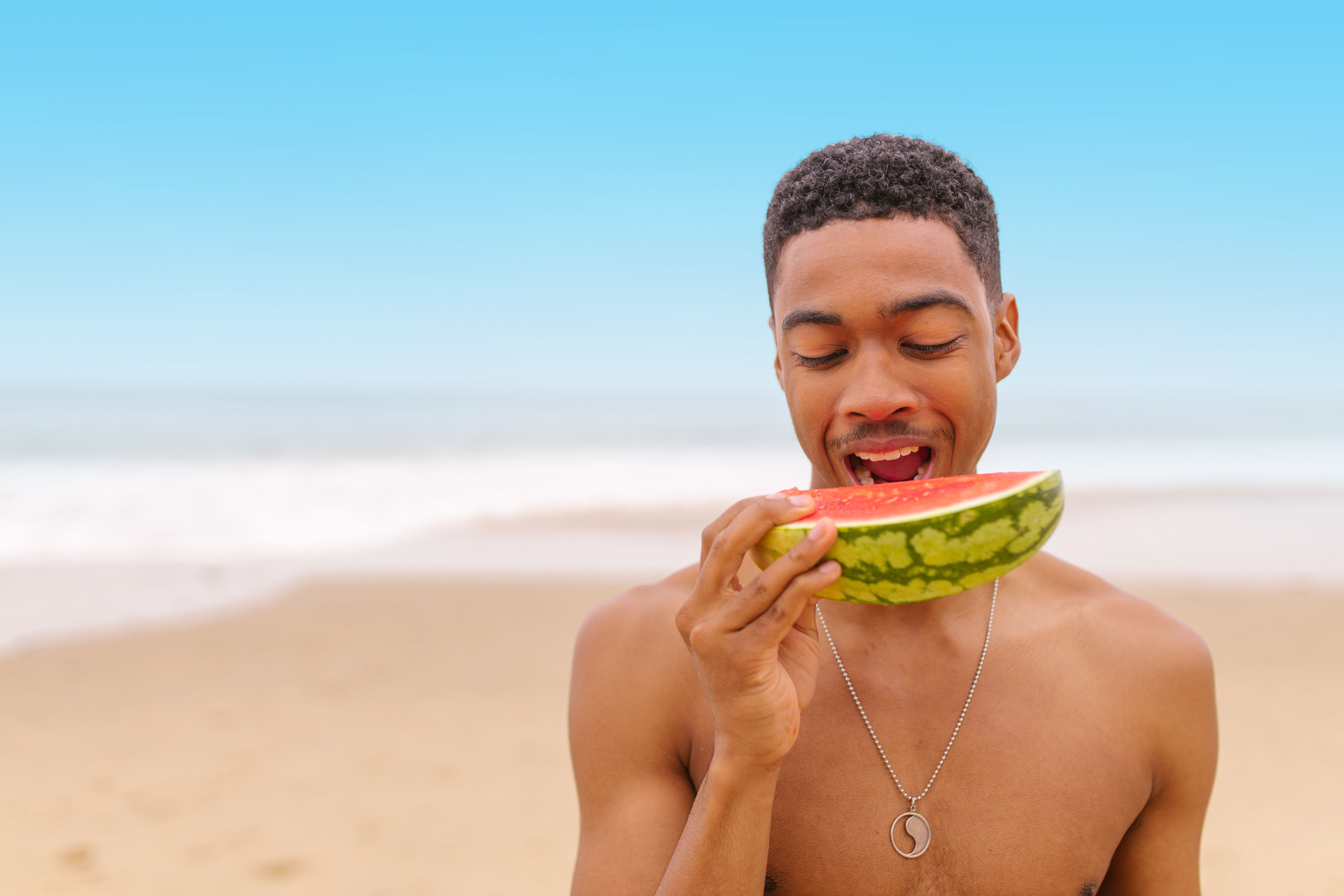 A Man Holding a Sliced Watermelon · Free Stock Photo