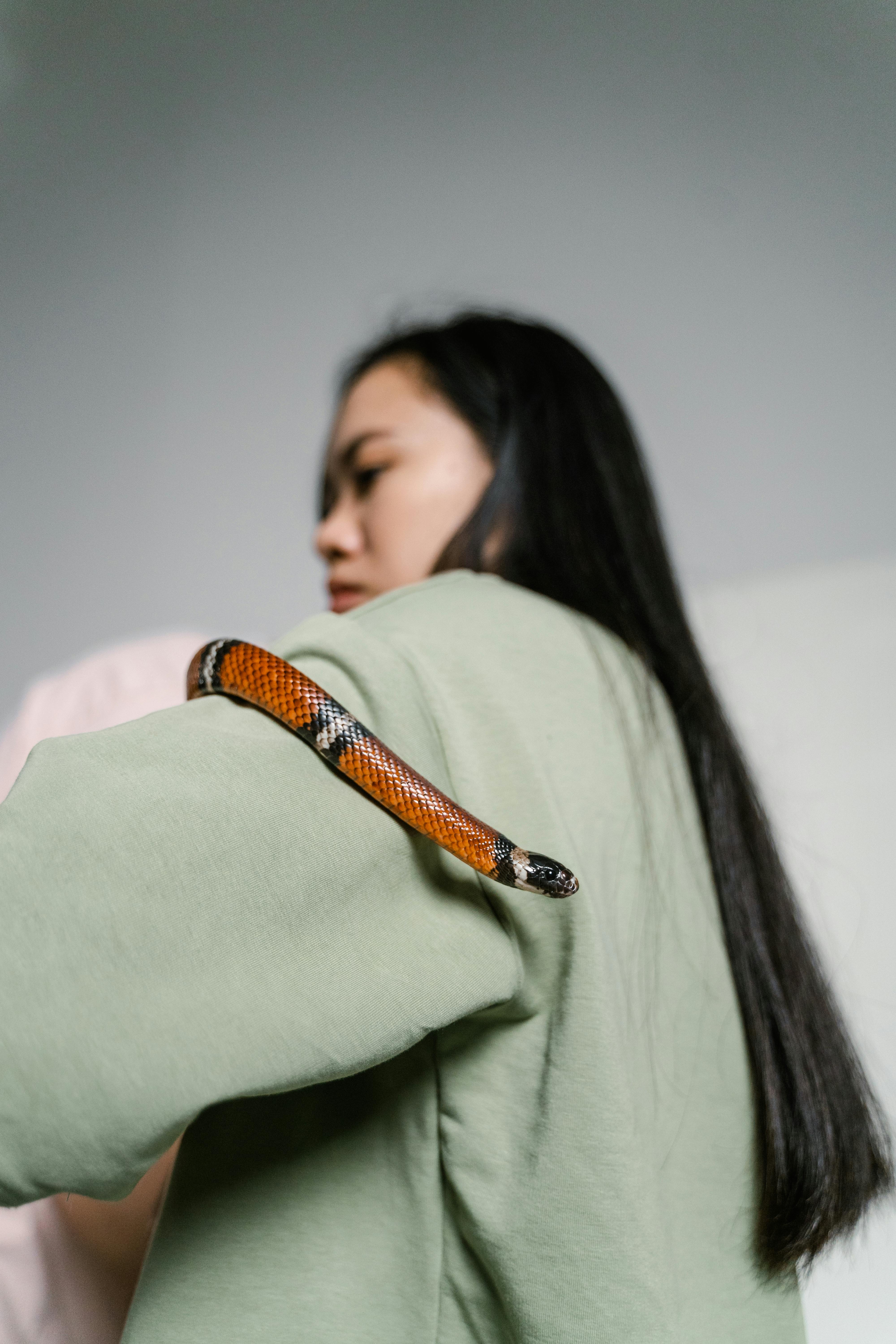 Close-Up Photo of a Woman Overcoming Her Fear of Snakes · Free Stock Photo