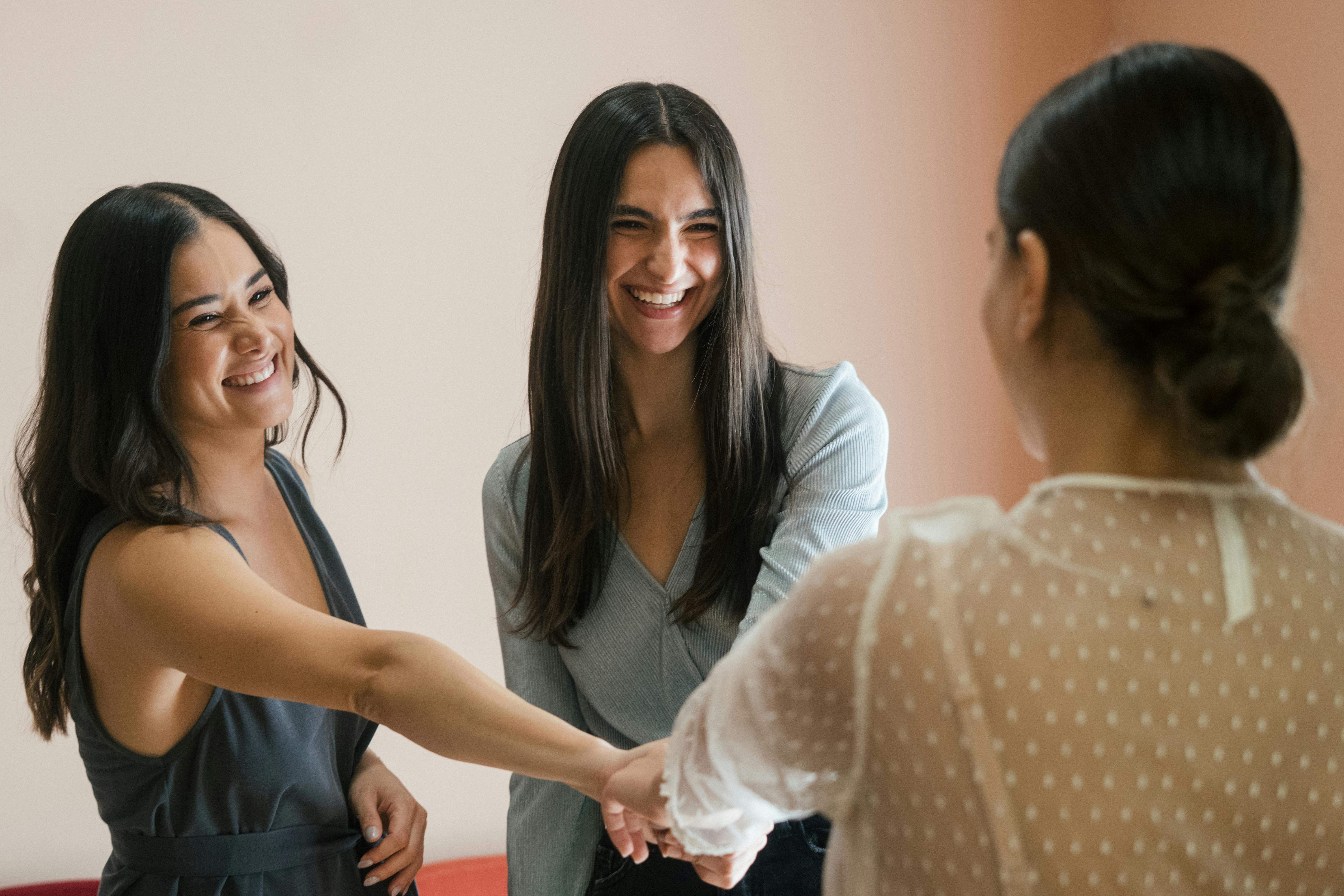 Happy Friends Stacking Hands · Free Stock Photo