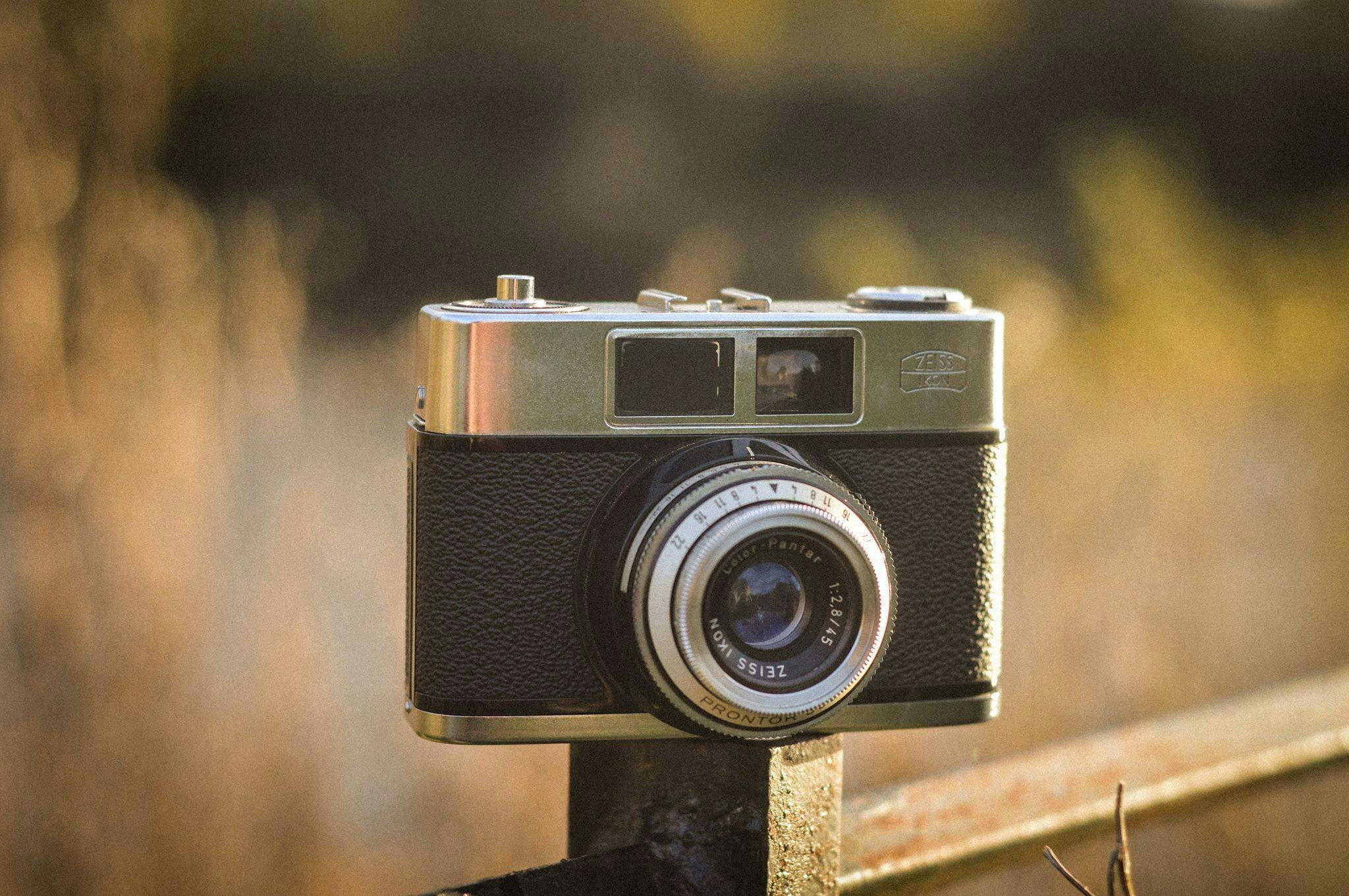 Photo Of Analog Camera On Wooden Surface · Free Stock Photo