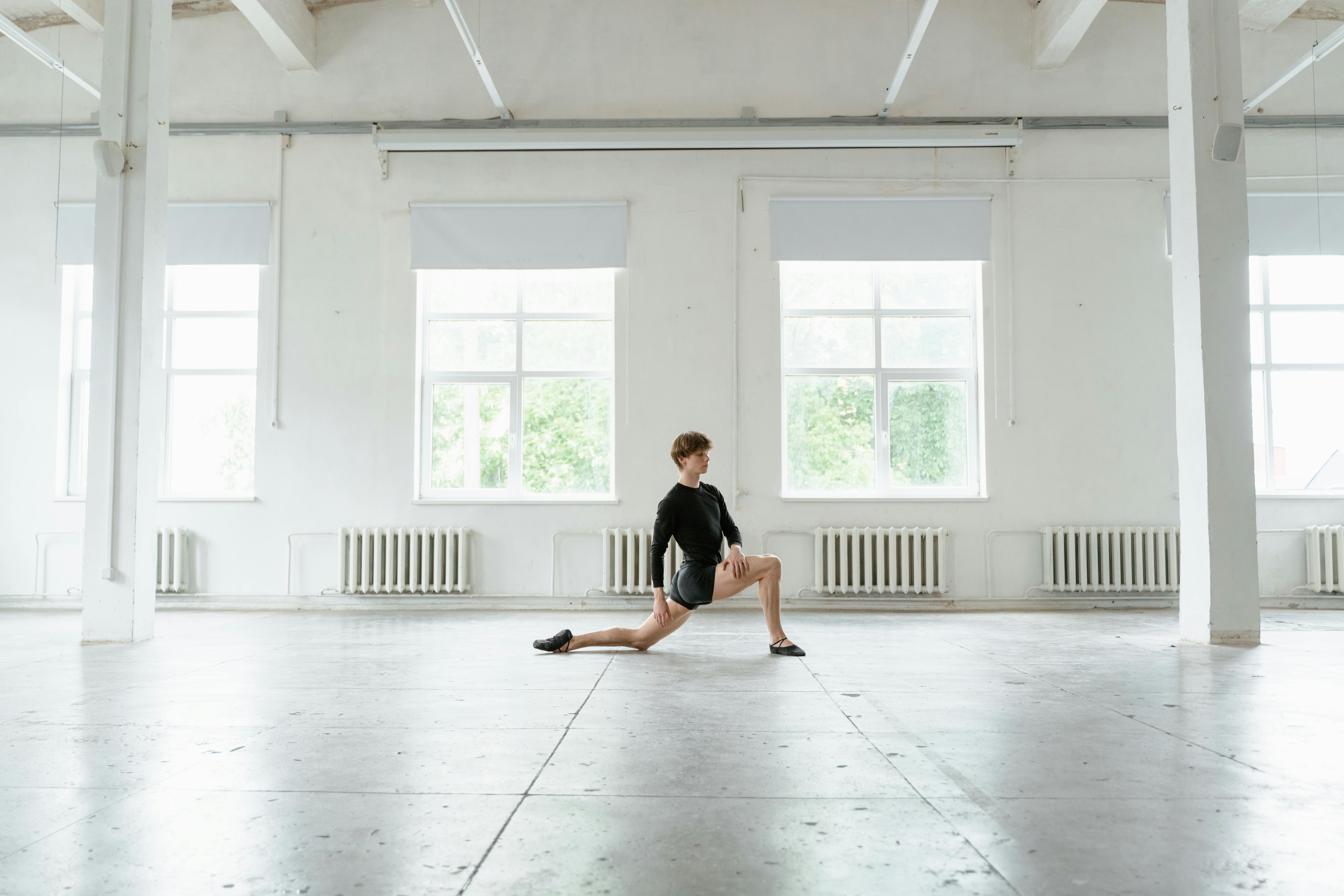 Ballet Dancer Stretching His Leg · Free Stock Photo