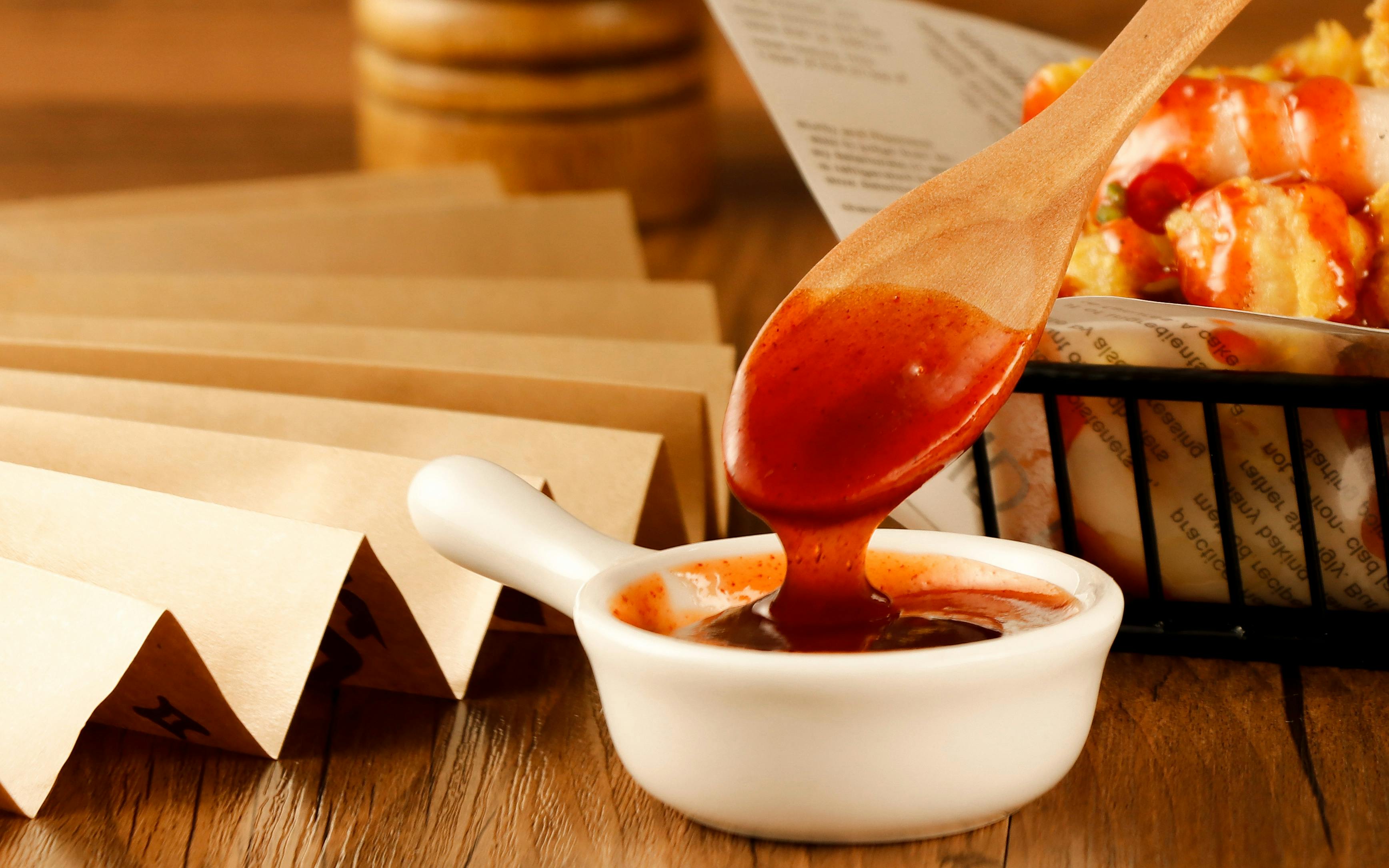 Close-up of a Wooden Spoon Dipped in Sauce · Free Stock Photo