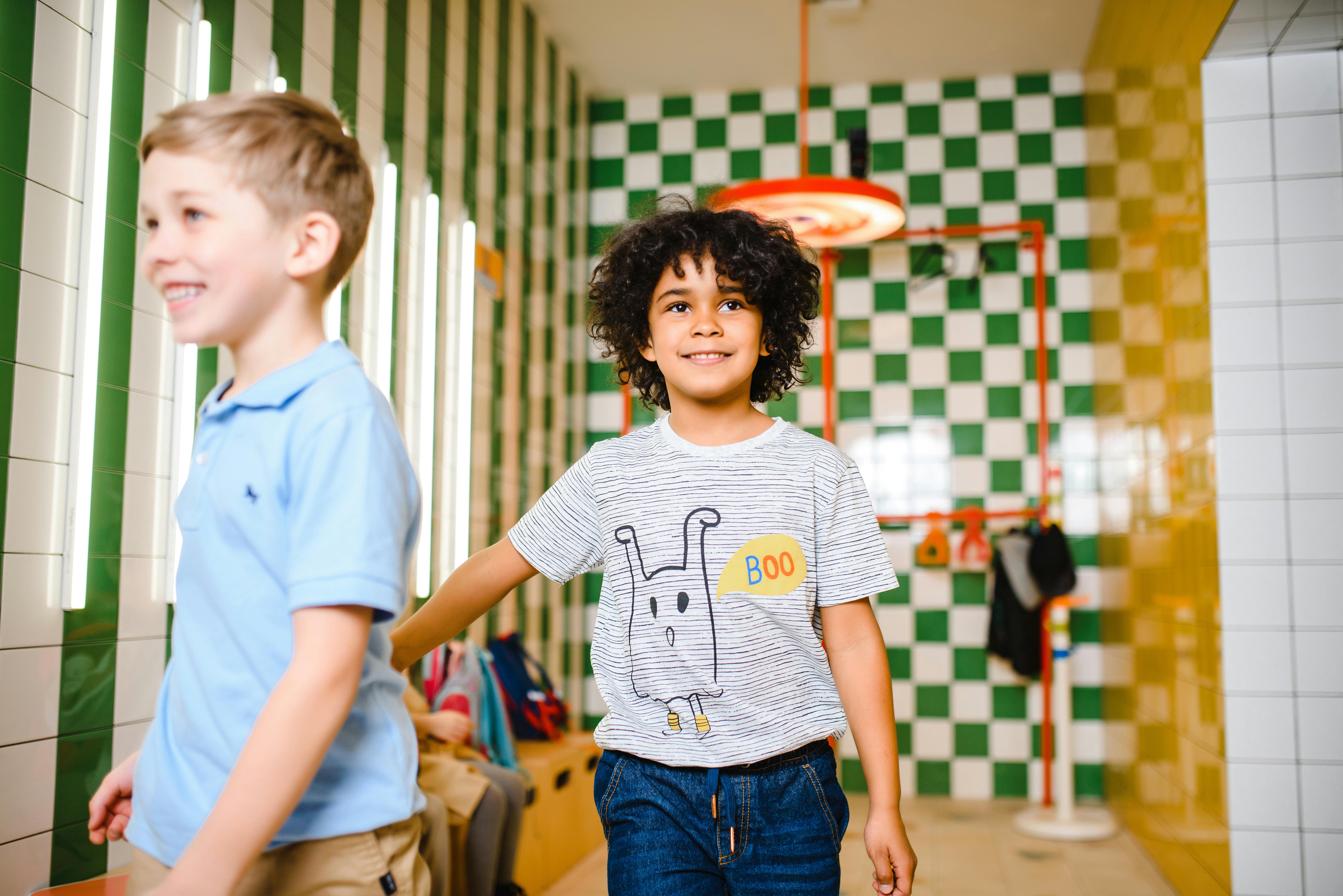 Boys Walking Inside a Room Smiling · Free Stock Photo
