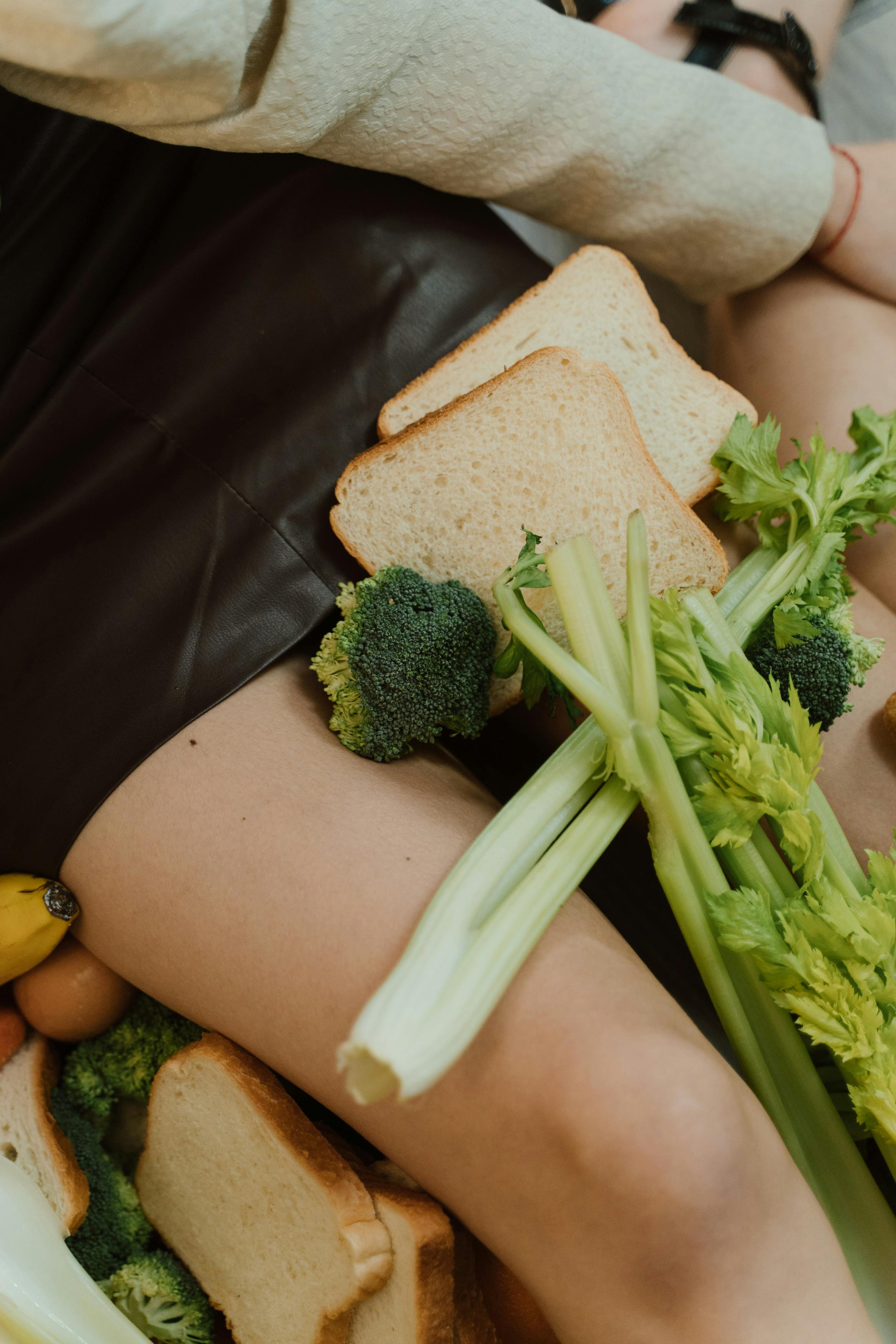 Vegetables and Bread Slices on Person's Lap · Free Stock Photo
