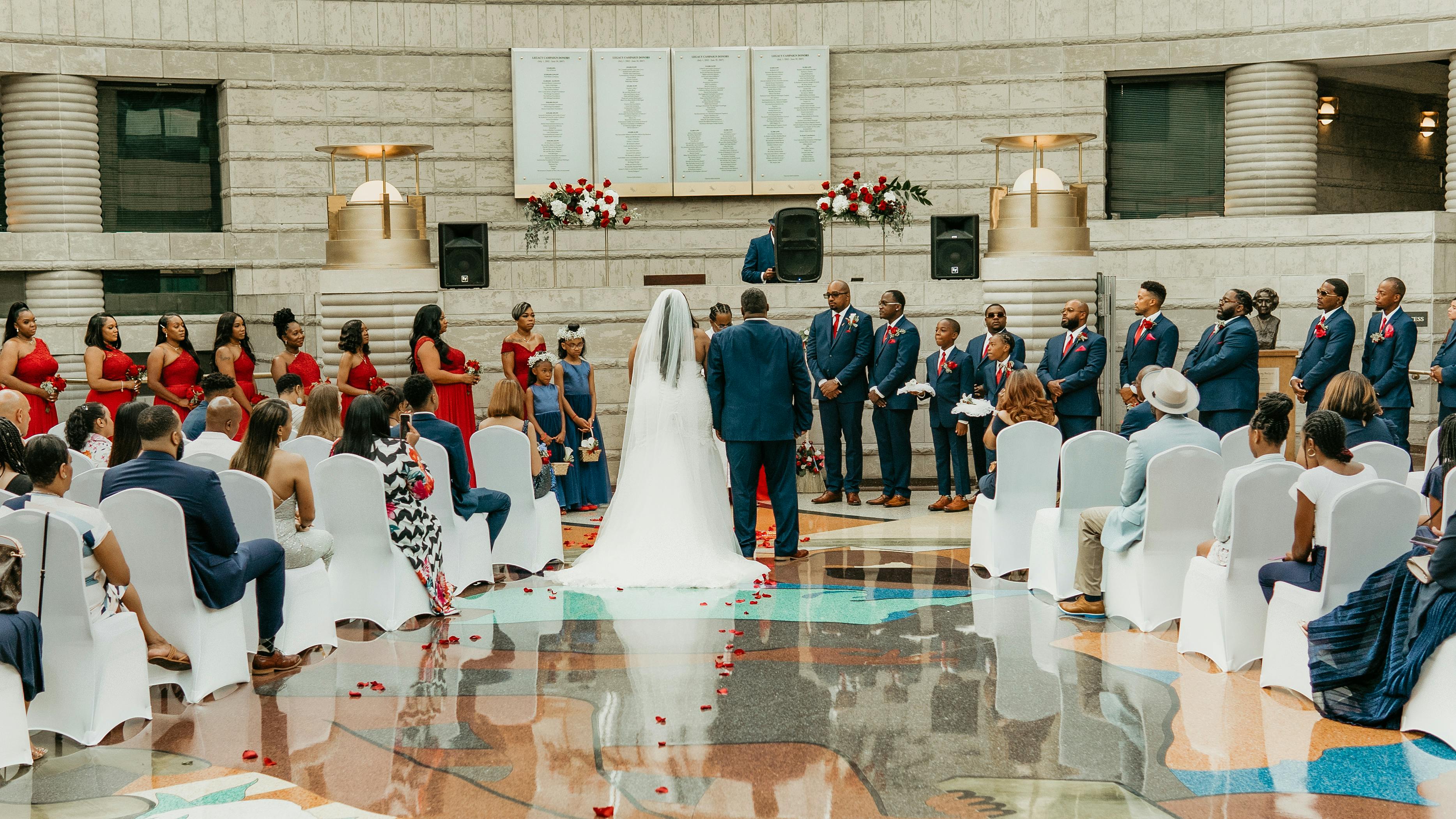 Anonymous bride with groom among guests during ceremony · Free Stock Photo