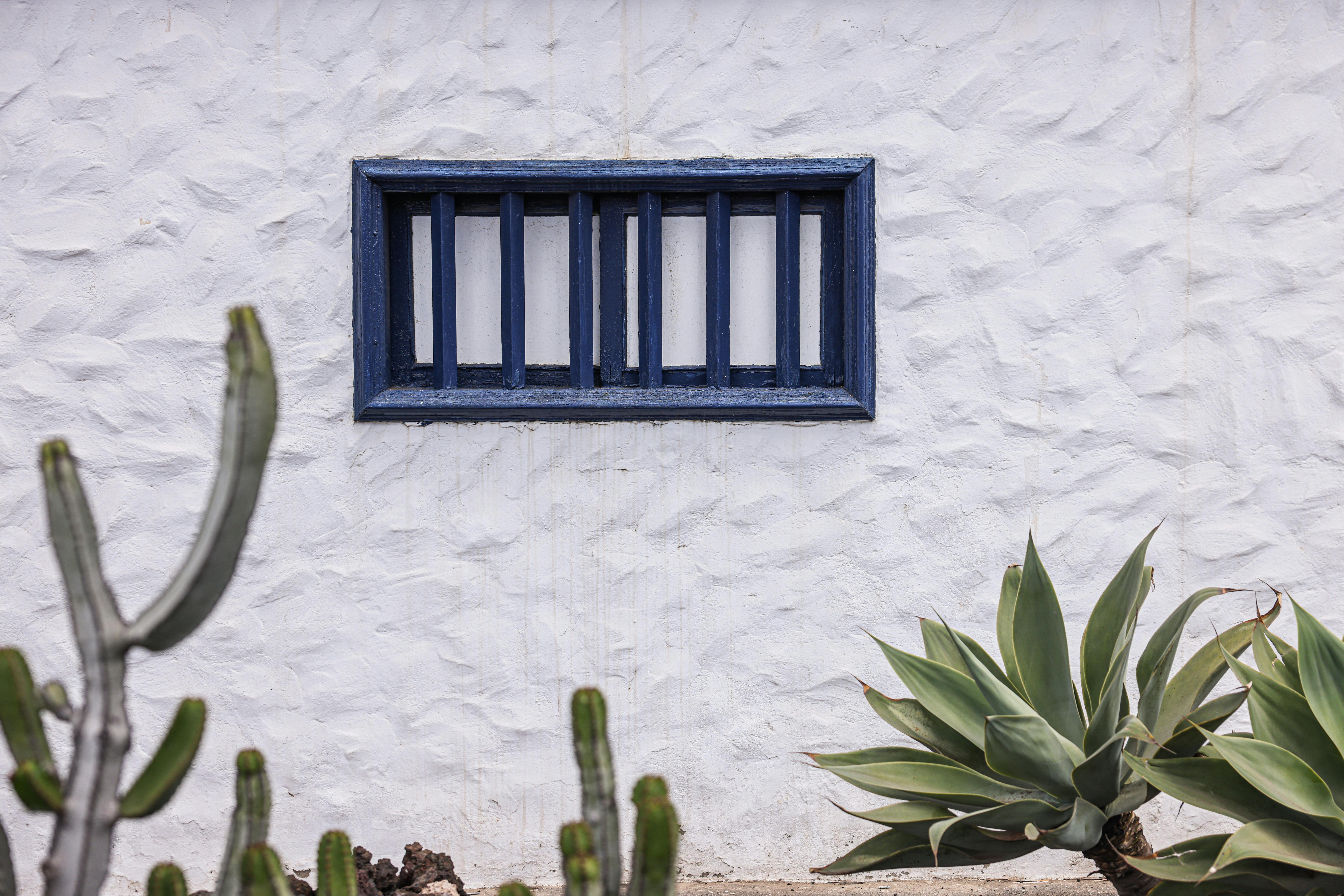 Blue Wooden Window Frame on White Concrete Wall · Free Stock Photo