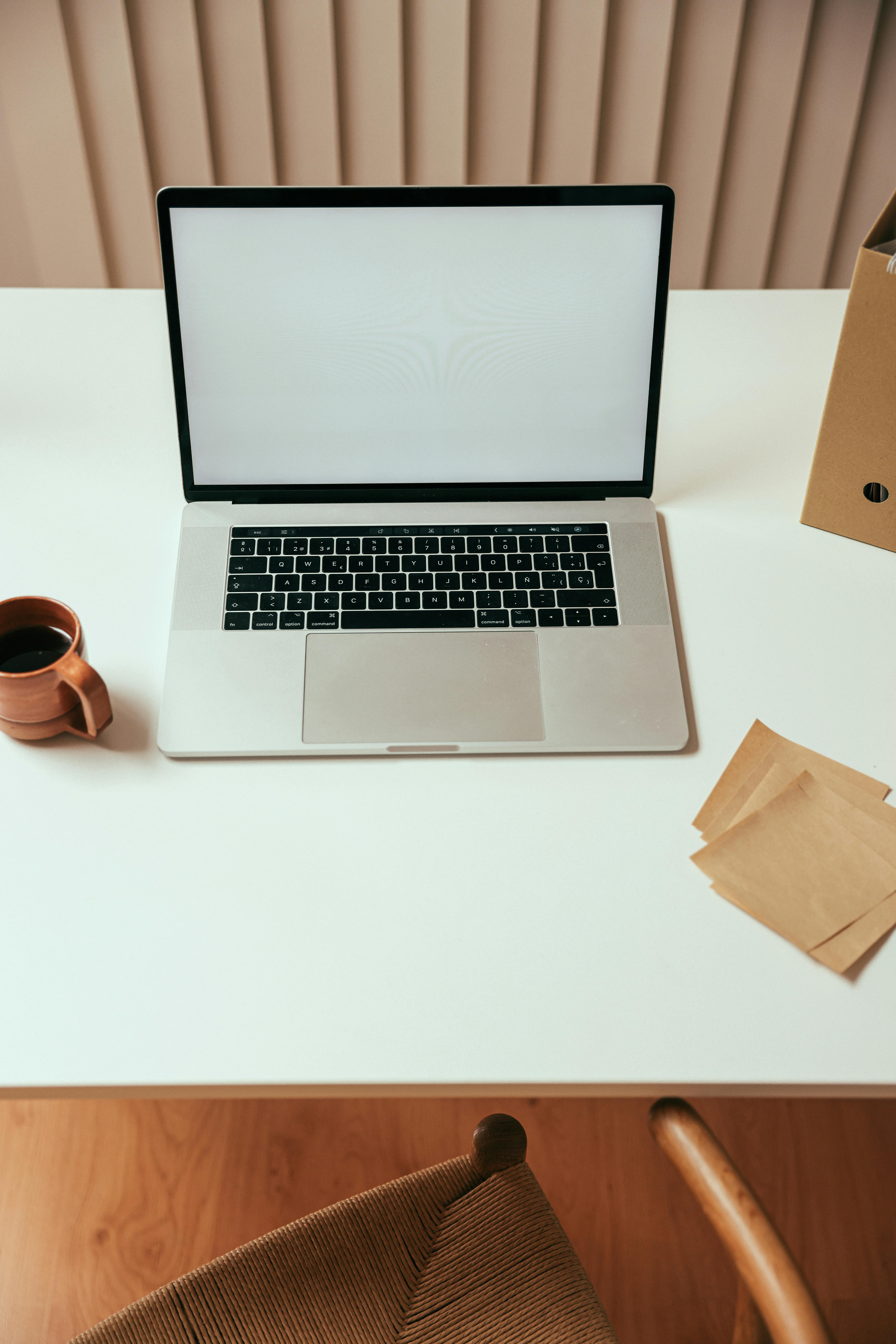 A Laptop on White Table · Free Stock Photo