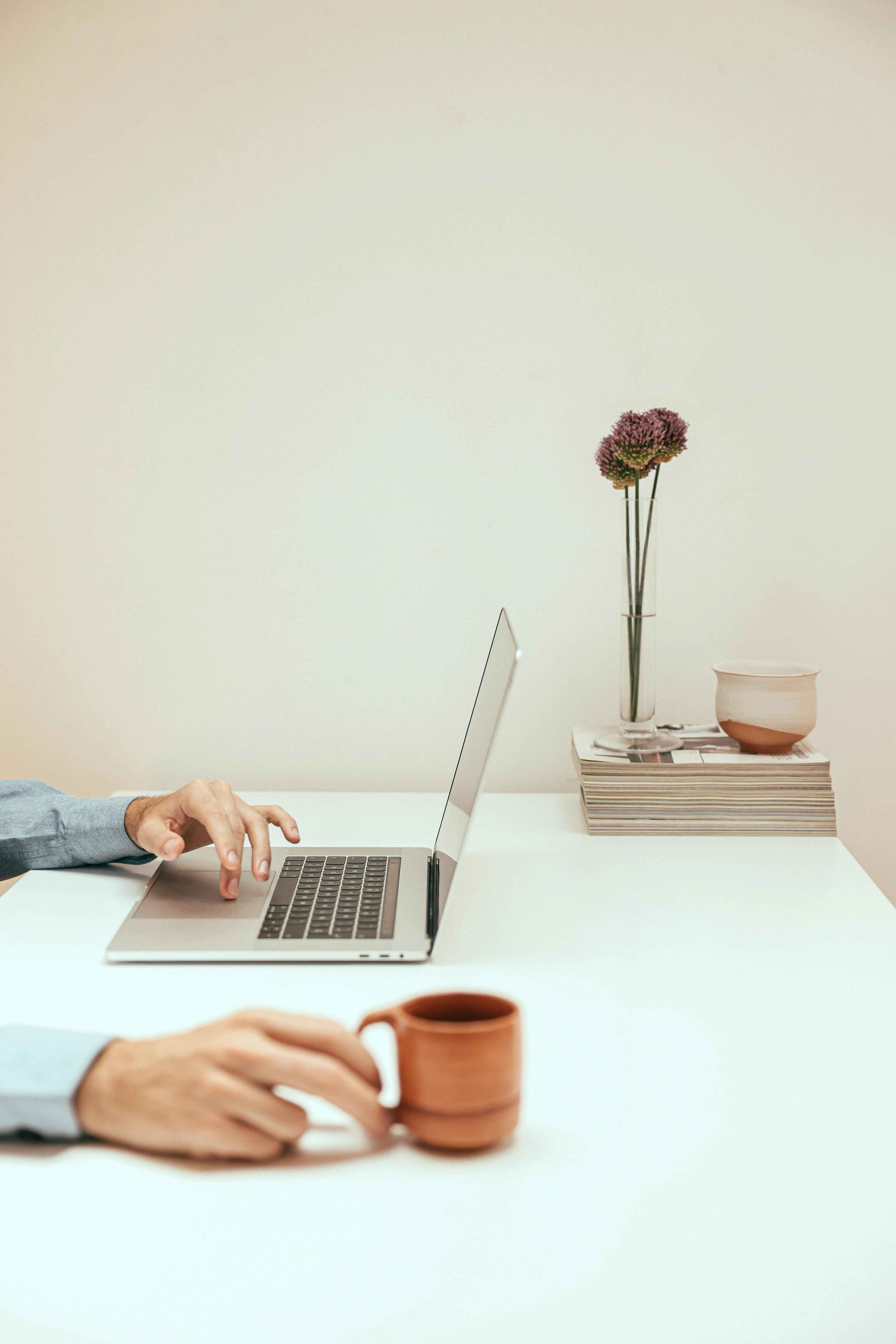 Crop remote employee working on laptop at home desk · Free Stock Photo