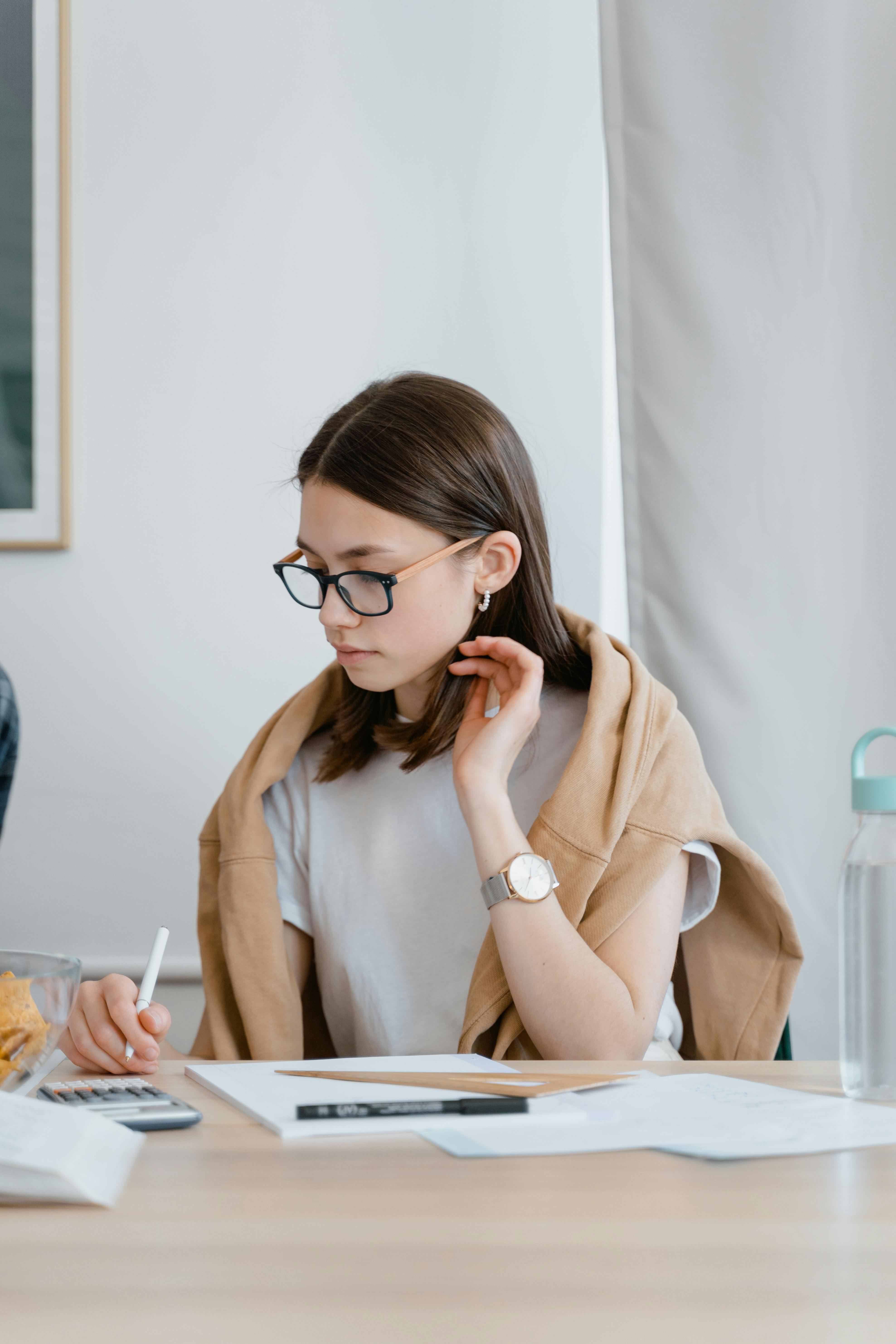 A Person Sitting on the Floor While Studying · Free Stock Photo
