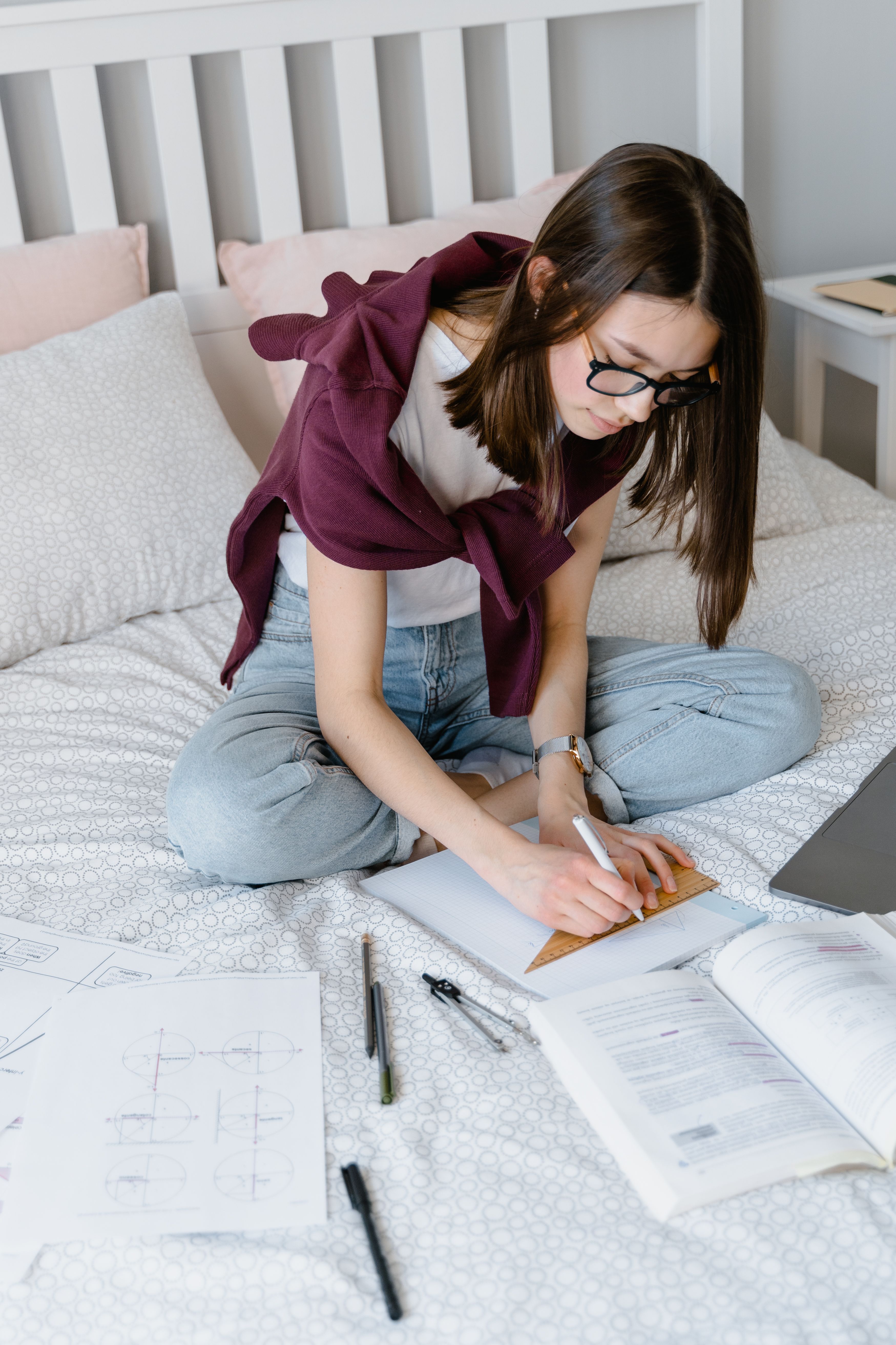 A Young Woman Drawing in a Notebook with a Set Square · Free Stock Photo