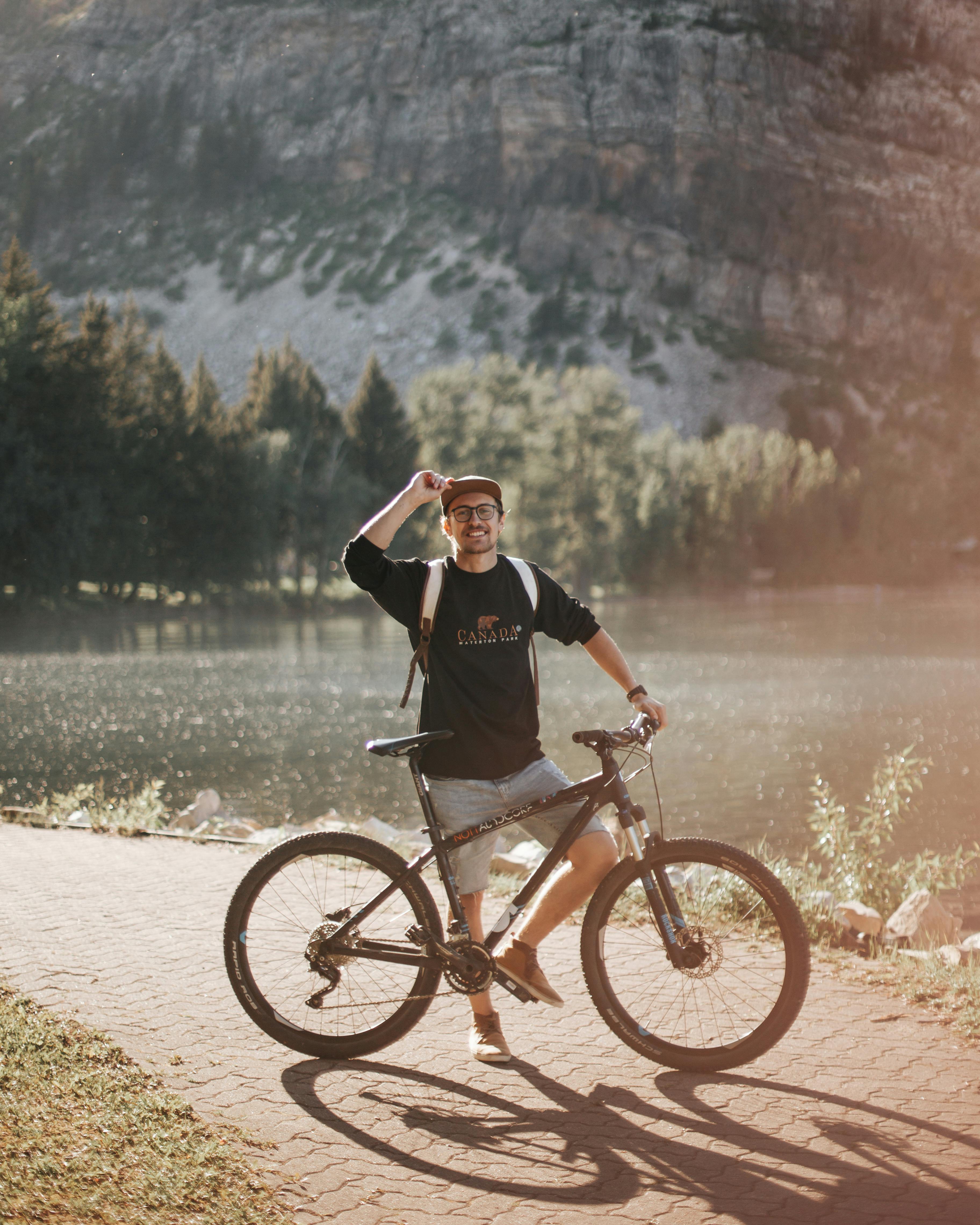 A Handsome Man Posing with a Bicycle · Free Stock Photo