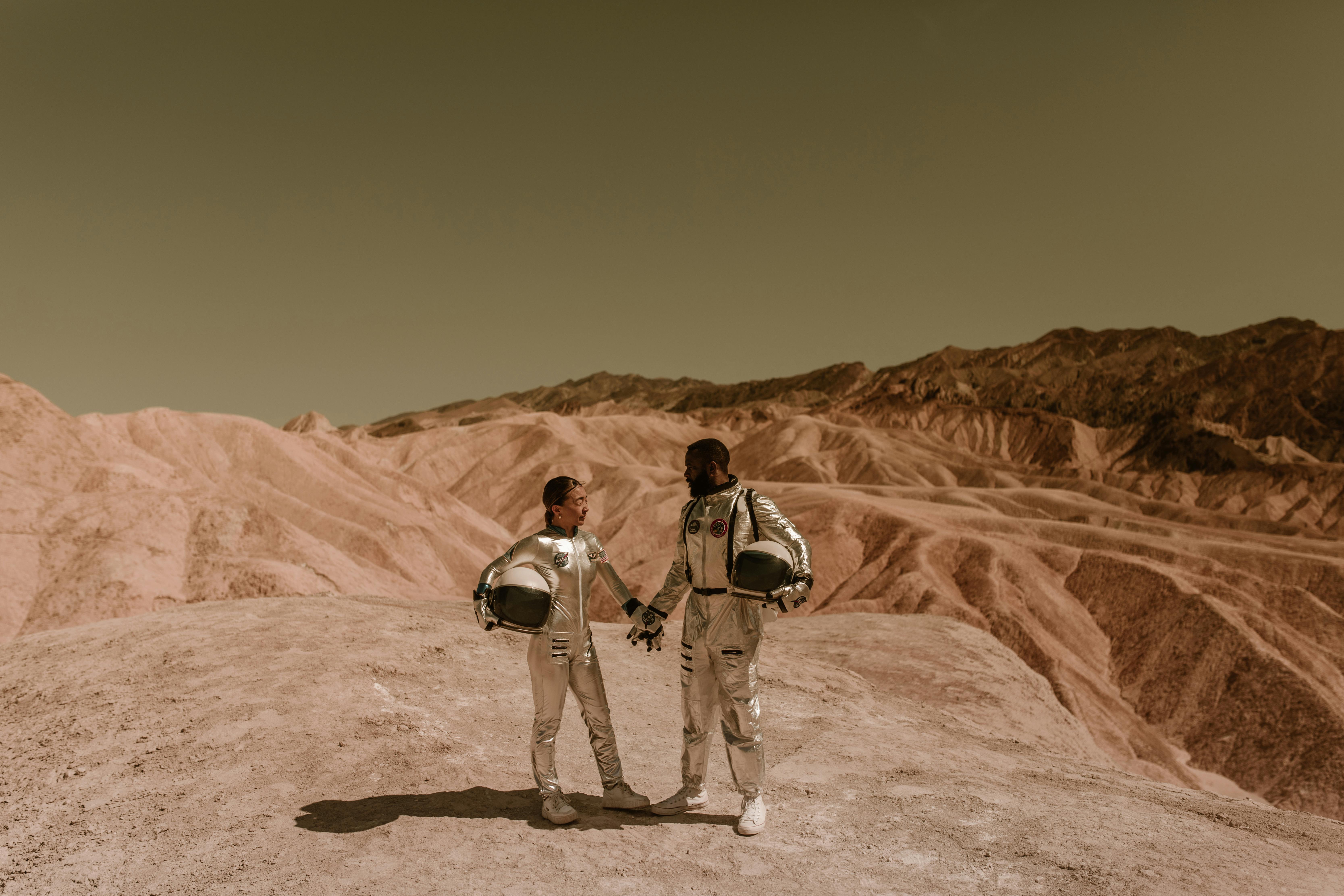 An Astronaut Couple Holding Hands on Mars · Free Stock Photo