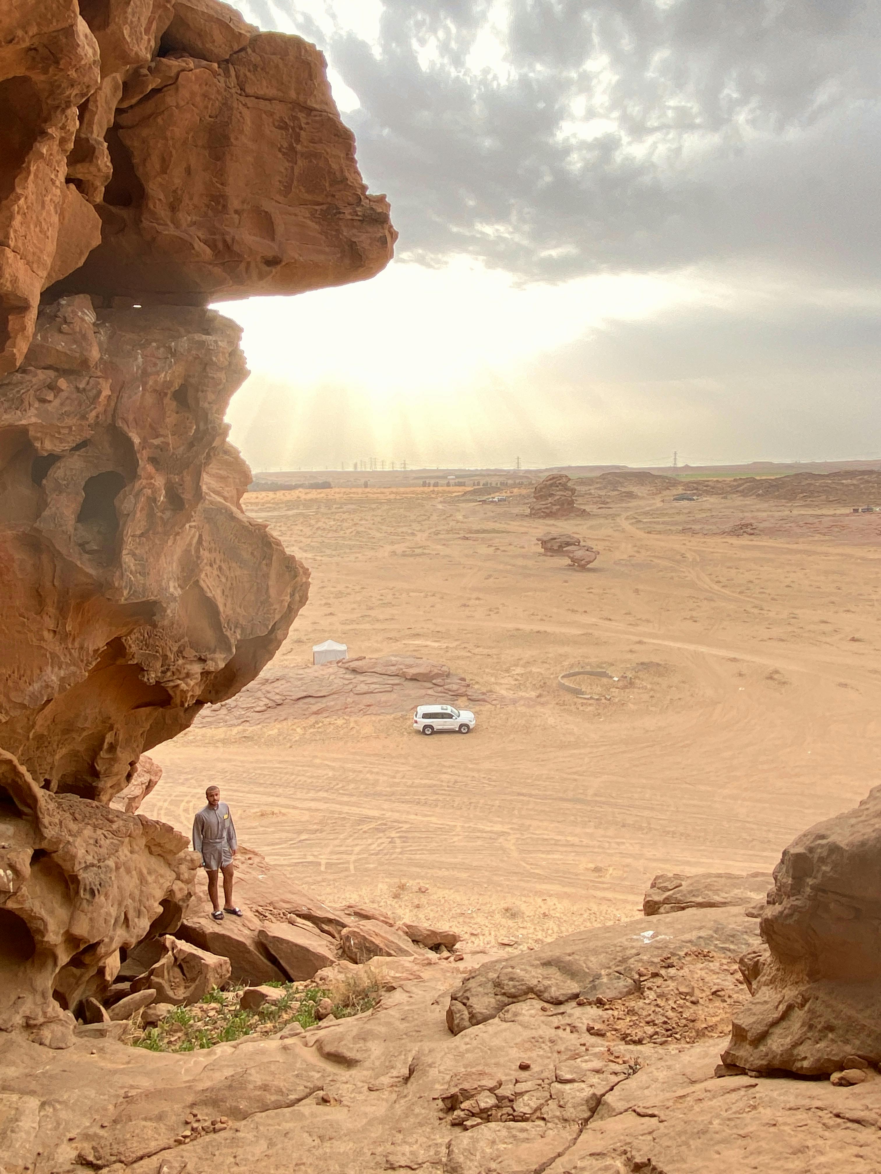 Person Standing under a Rock Formation · Free Stock Photo