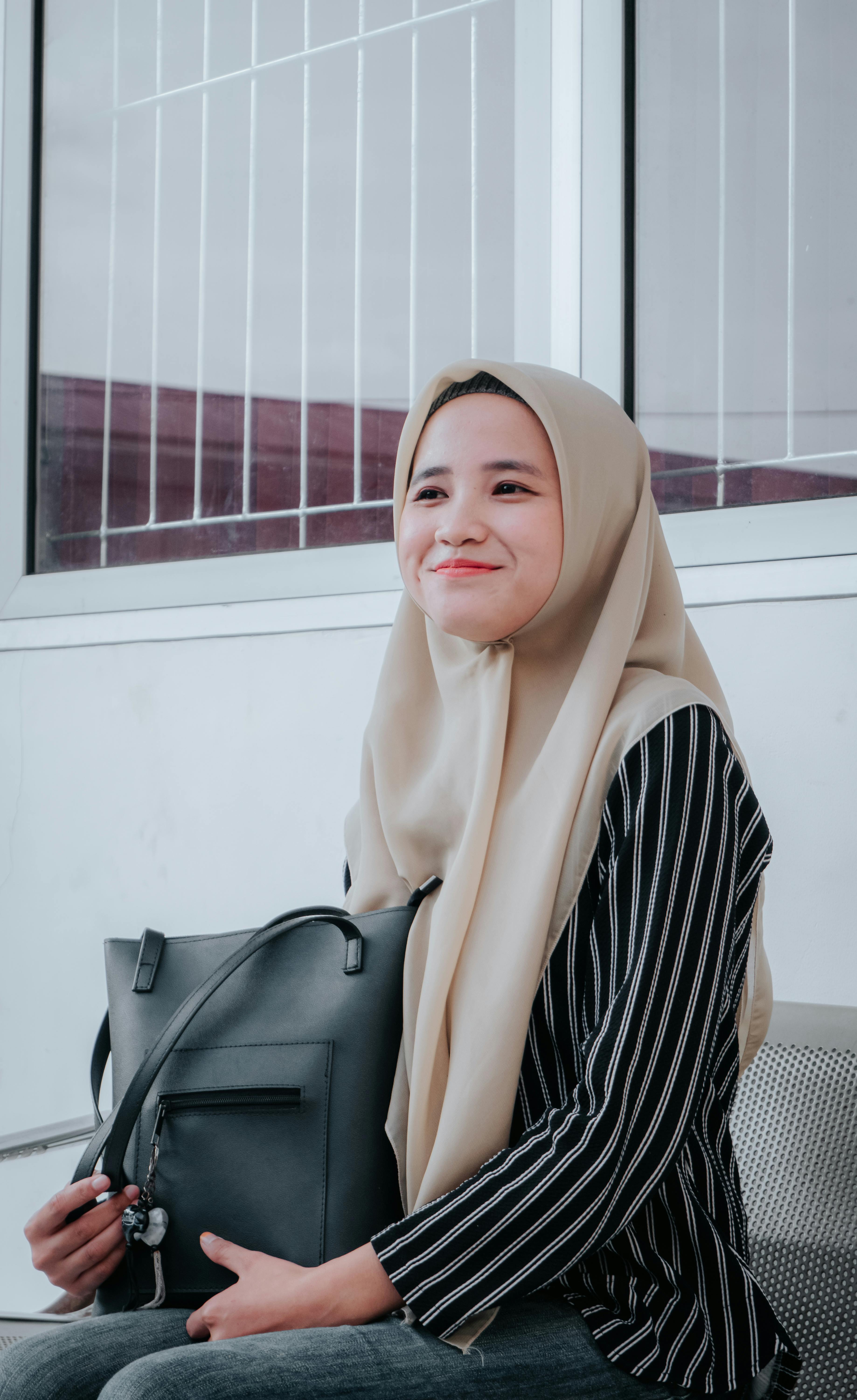 A Woman with Pink Hijab Packing Street Food in a Plastic · Free Stock Photo