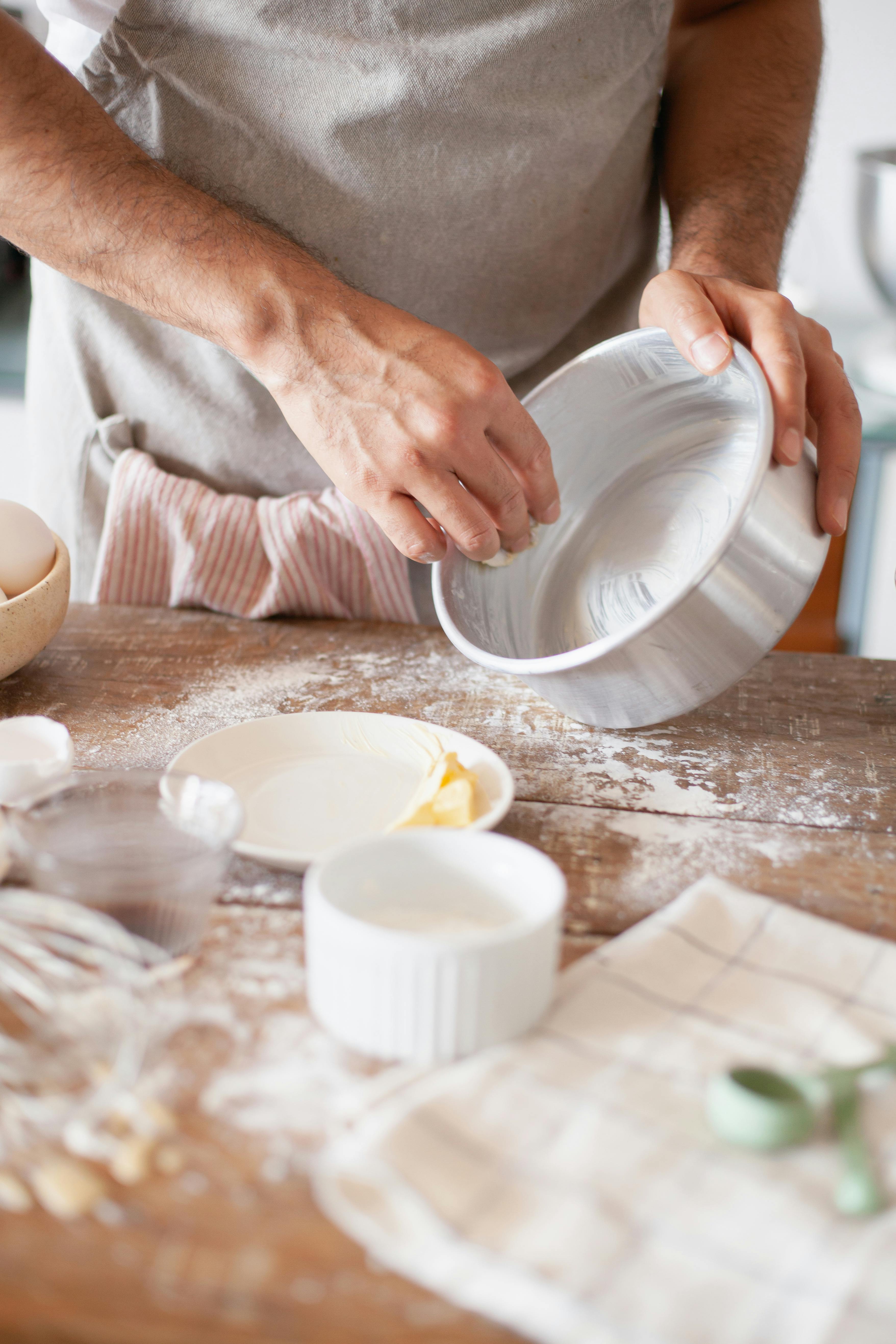 Man Wiping Butter on a Bowl · Free Stock Photo
