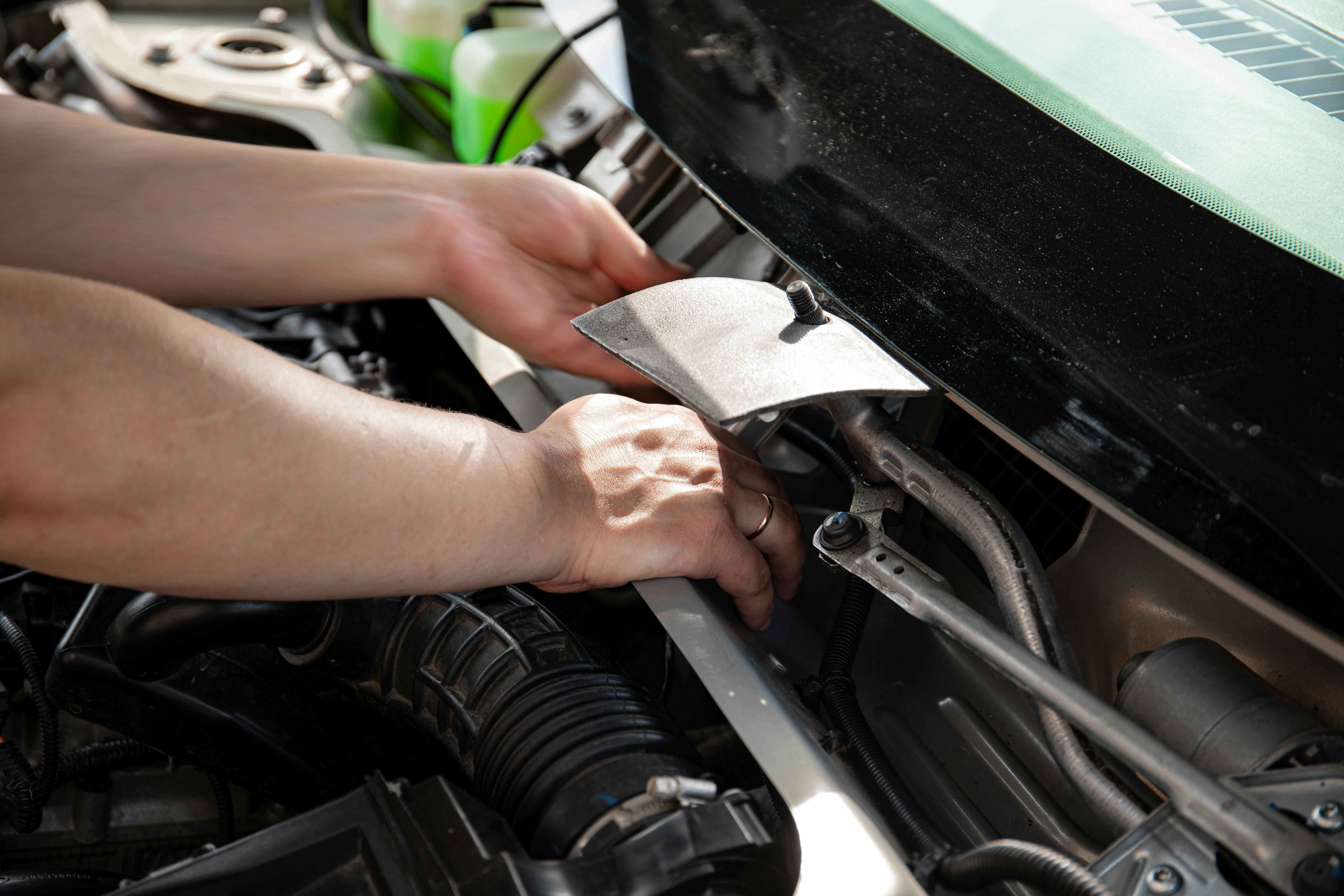 Person Fixing a Car · Free Stock Photo