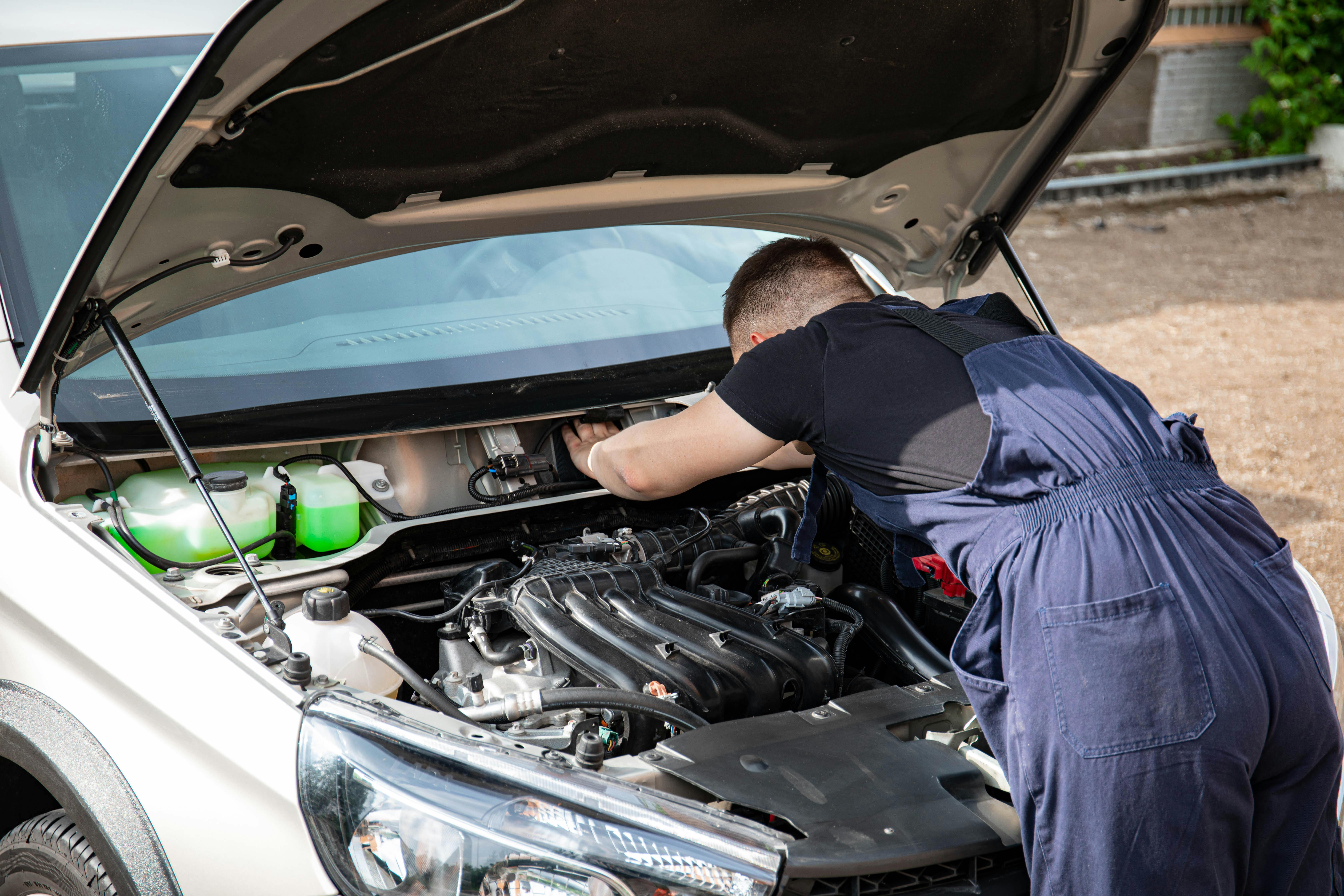 Person Fixing a Car · Free Stock Photo