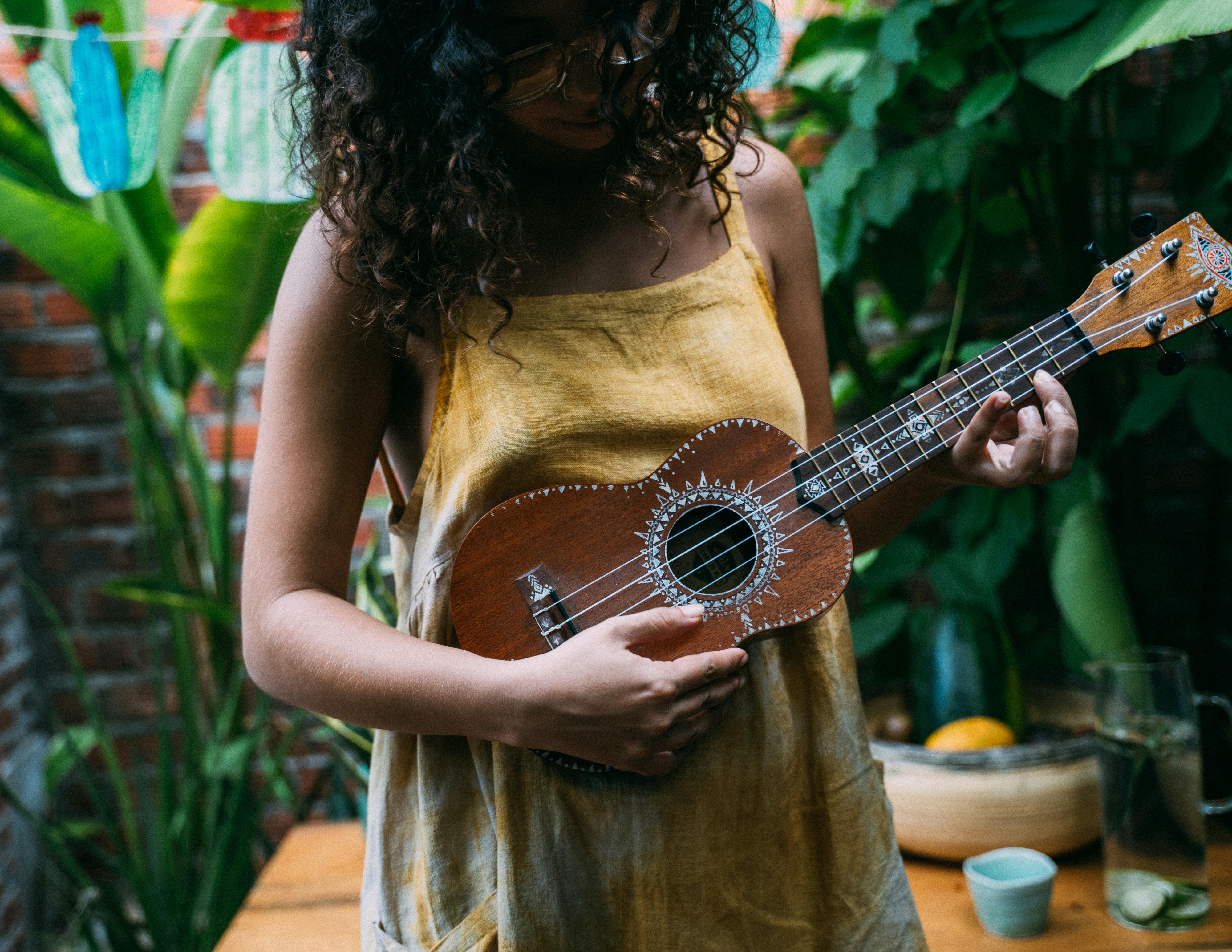 Photograph of a Man Playing a Ukulele Near a Woman Dancing · Free Stock ...