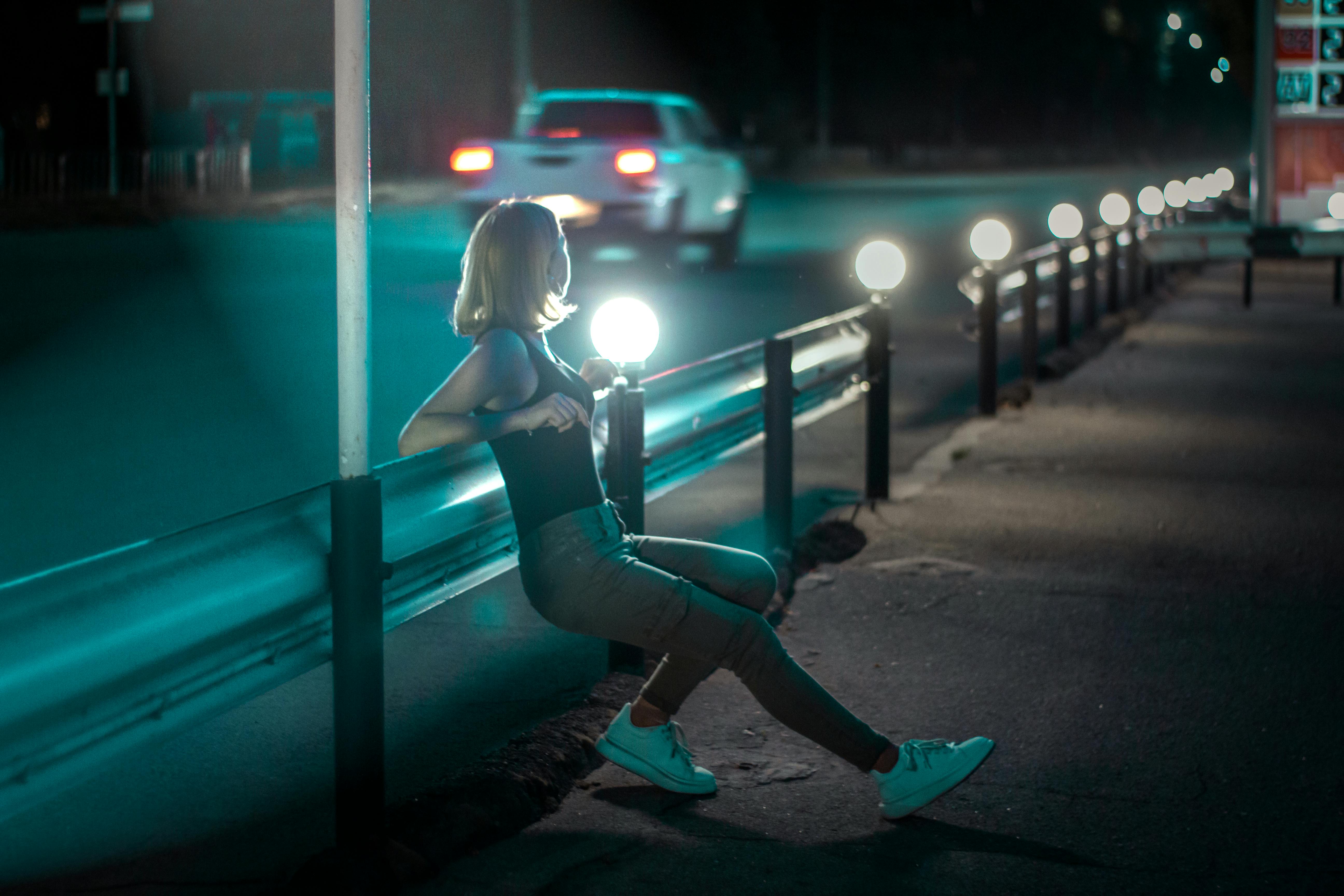 Person Leaning on Road Railings at The Side of a Road · Free Stock Photo