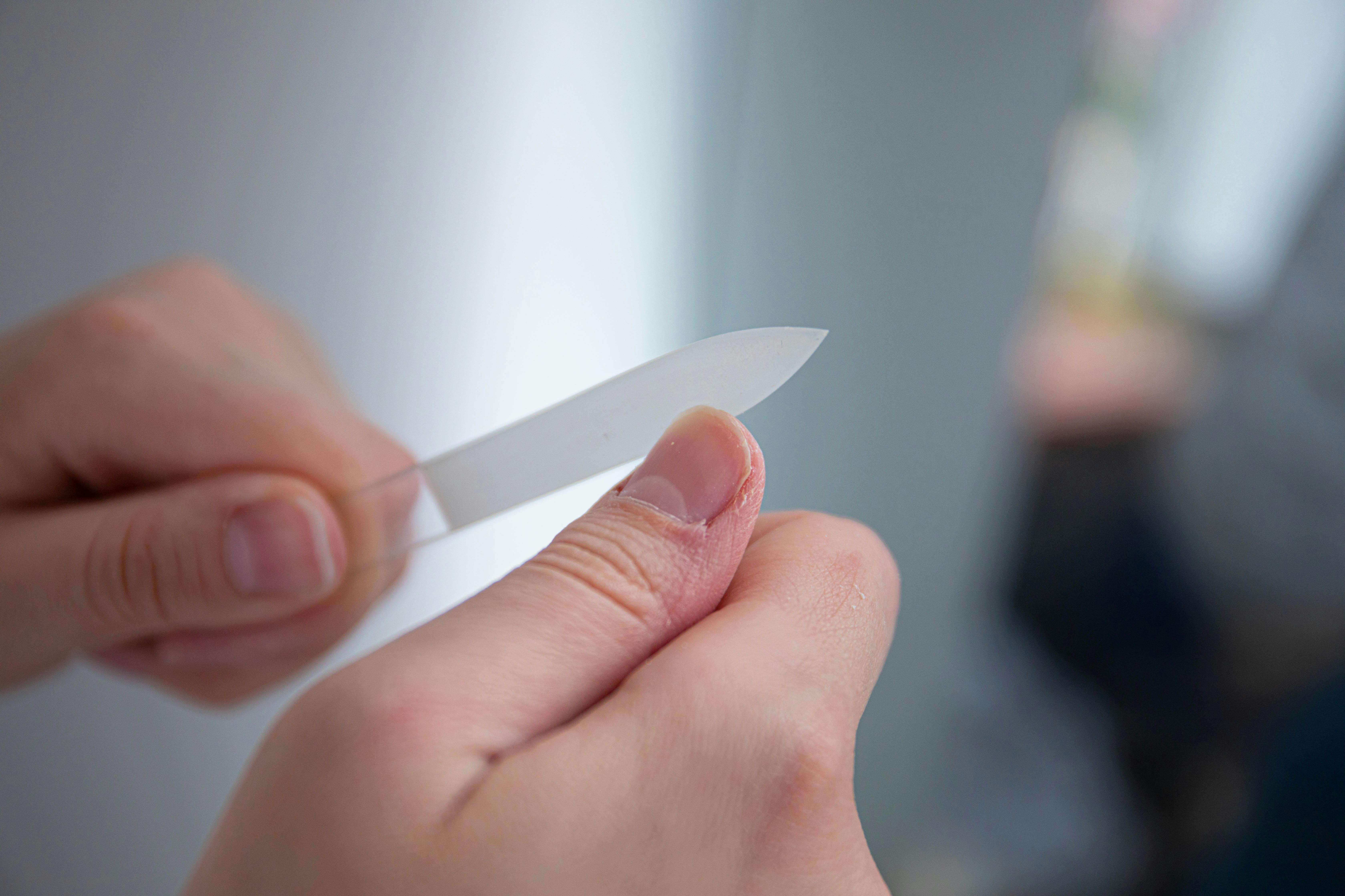 Person Holding White Nail File · Free Stock Photo