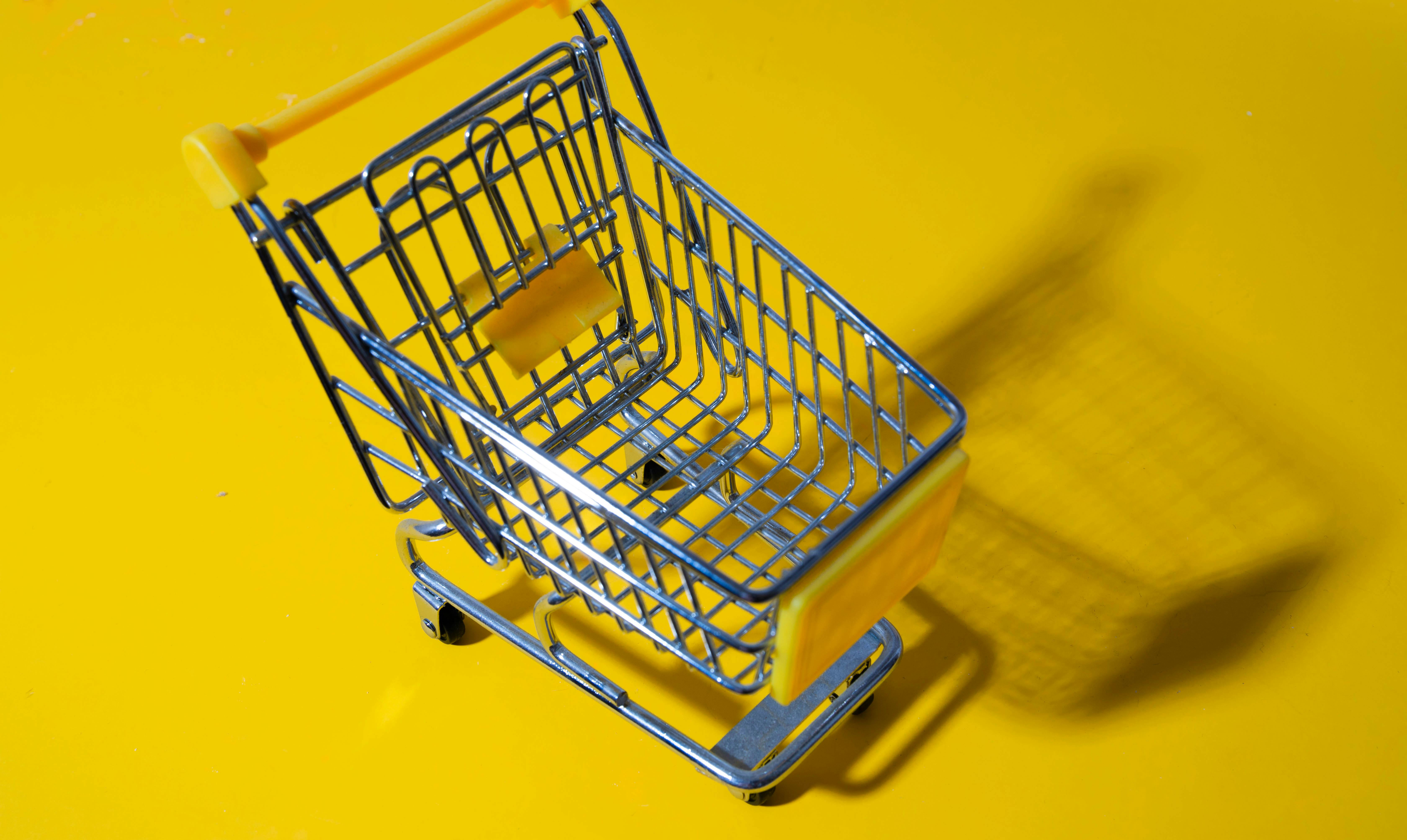 Photo of Push Cart Against Yellow Background · Free Stock Photo