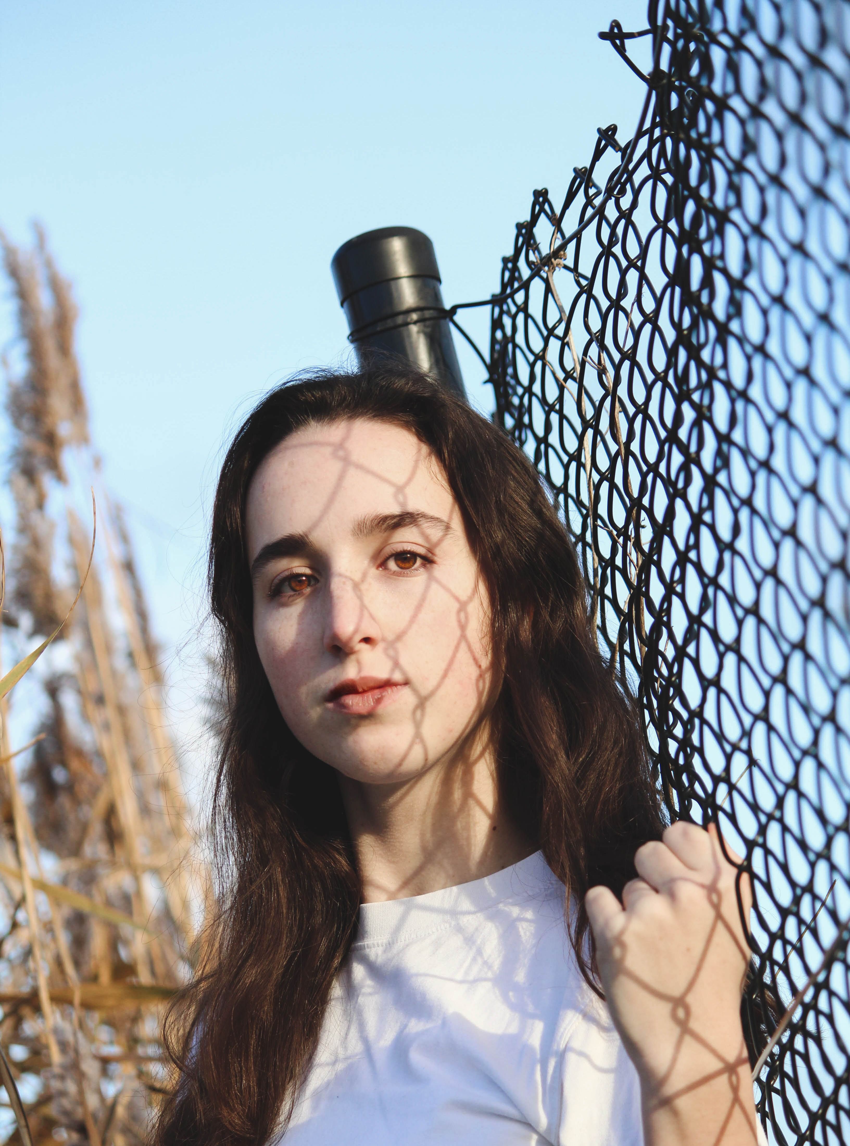 Two Women Leaning On Fence · Free Stock Photo