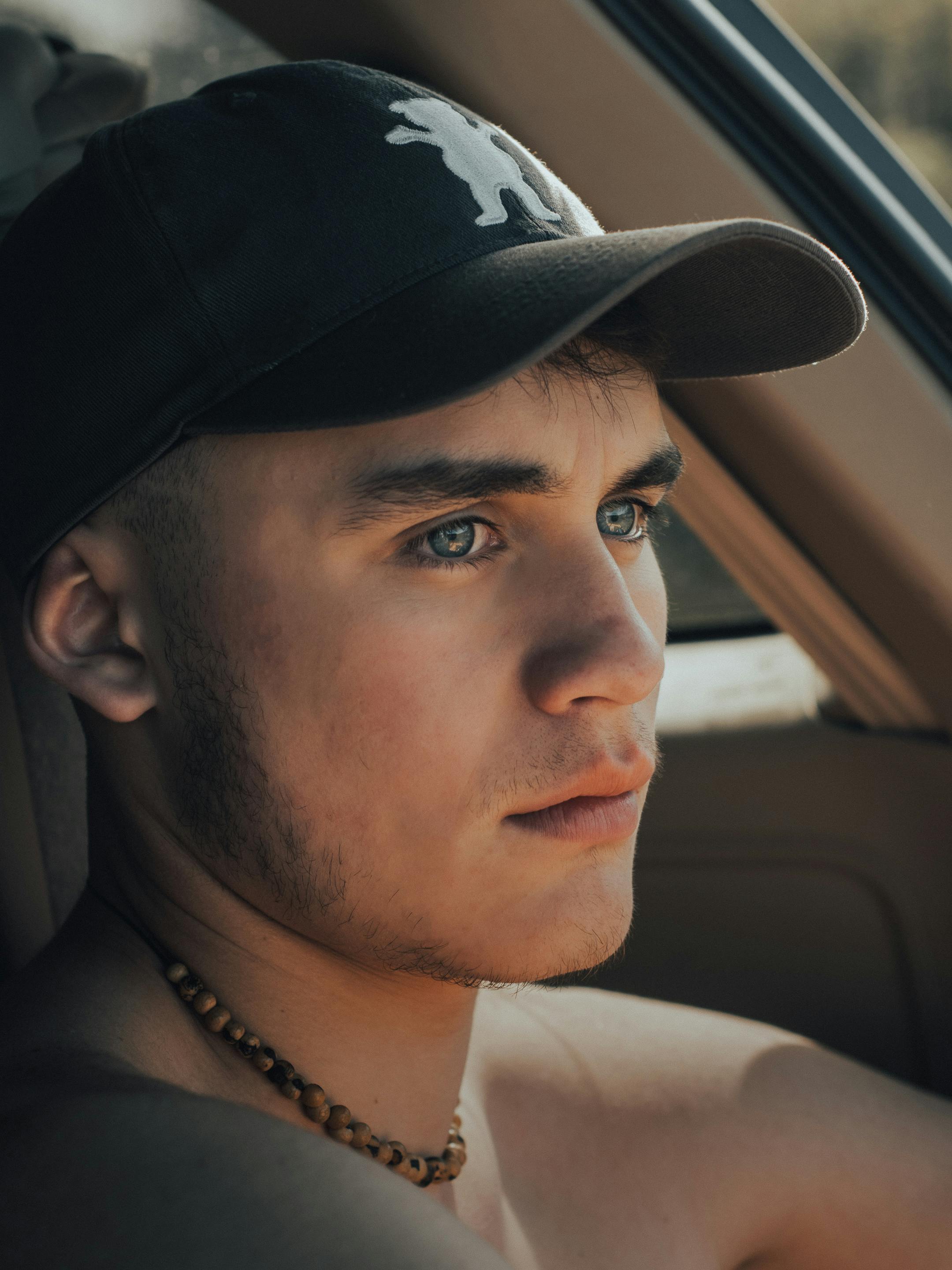 A Young Man Wearing a Black Cap · Free Stock Photo