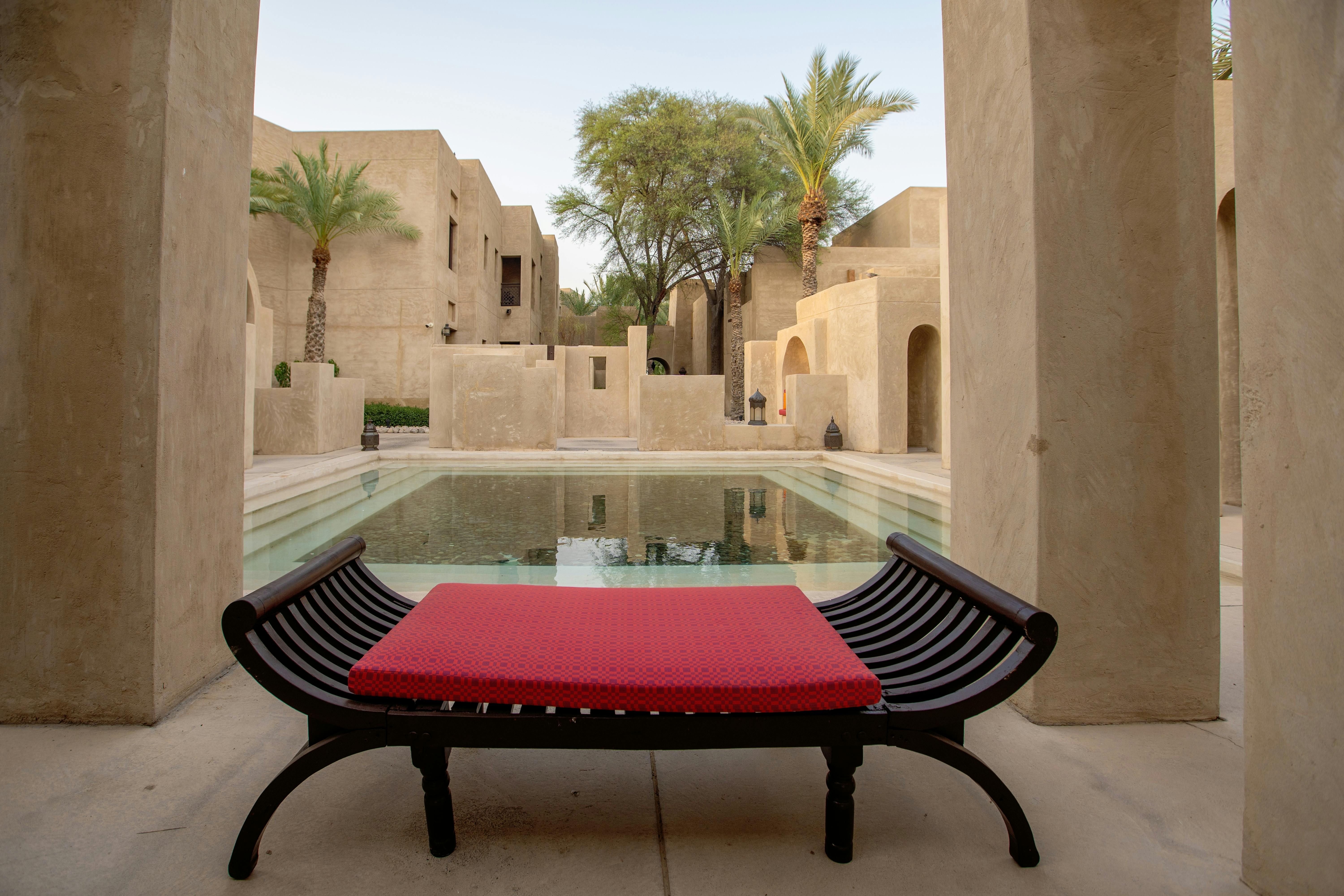 Wooden Bench Near a Swimming Pool · Free Stock Photo