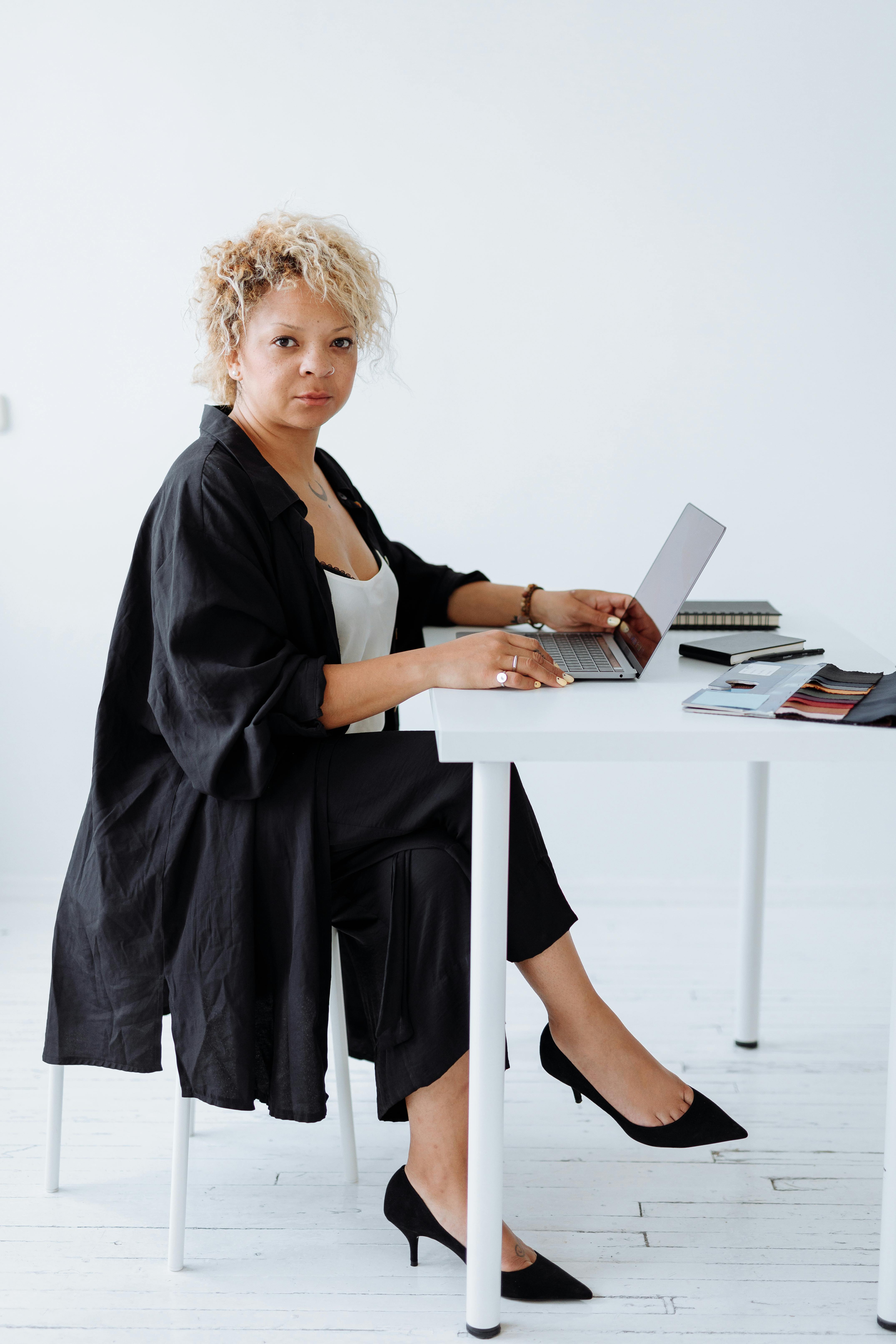 Woman Using a Laptop Inside the Office · Free Stock Photo