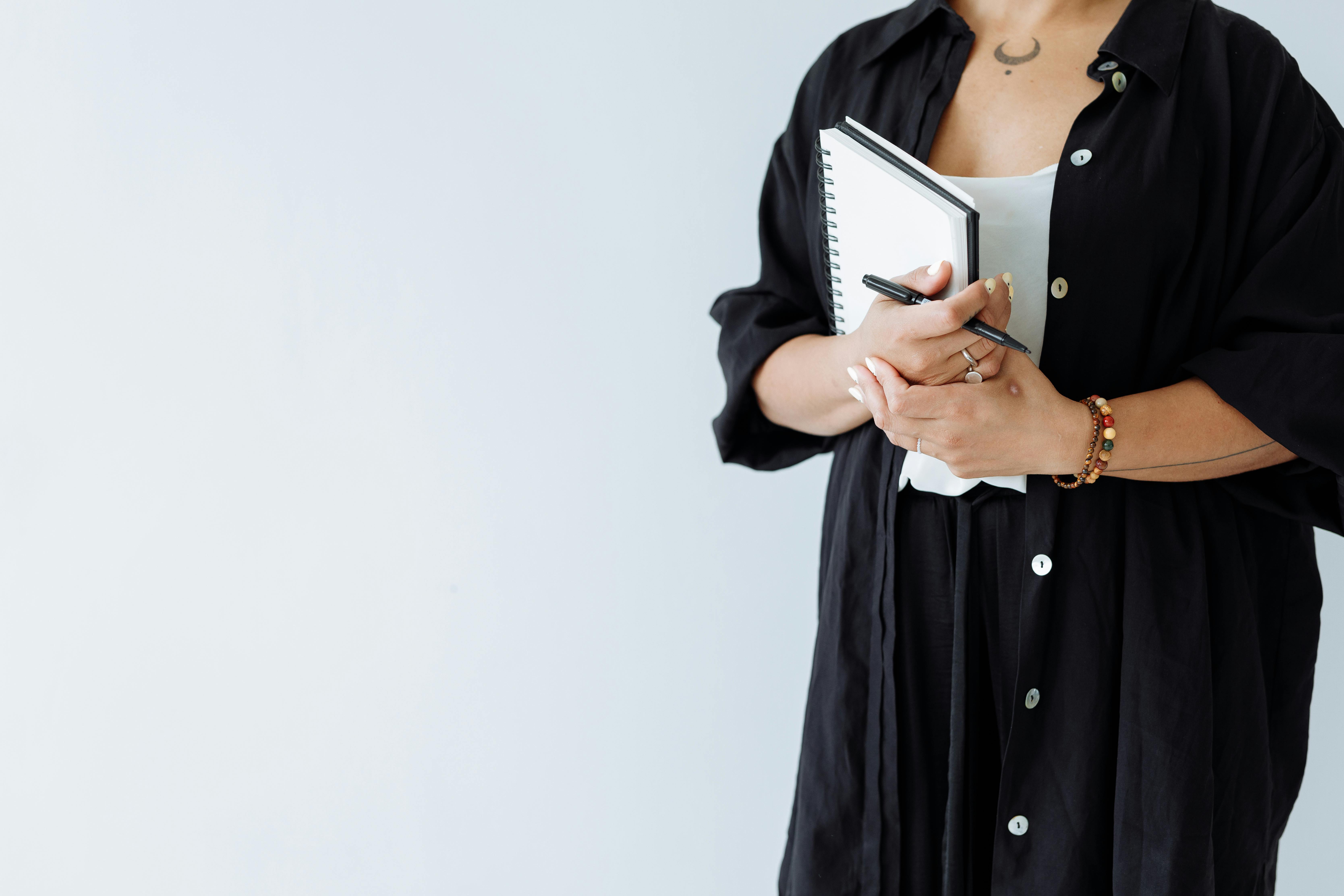Woman Holding a Notebook · Free Stock Photo