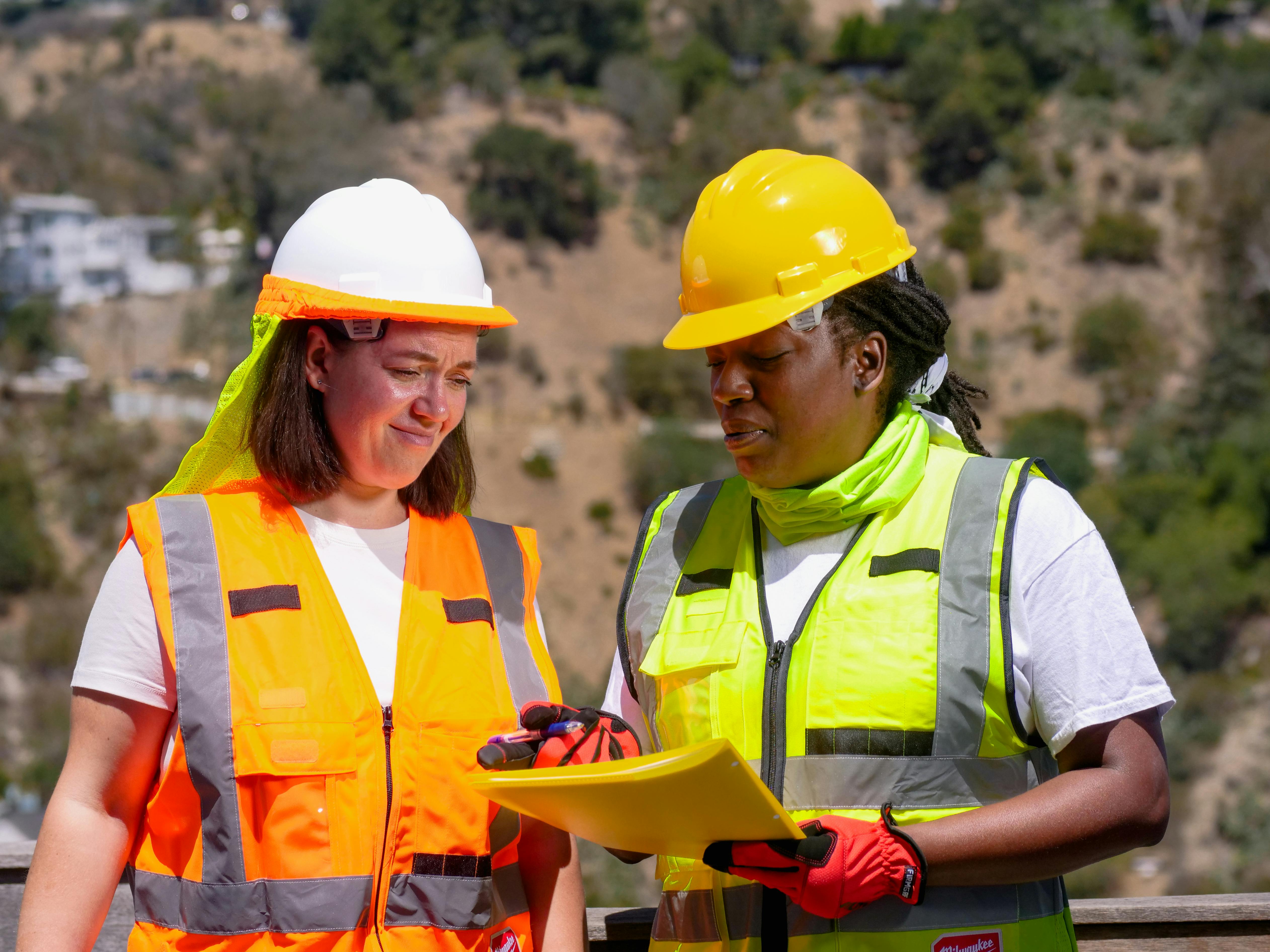 Female Engineers Talking with Each Other · Free Stock Photo