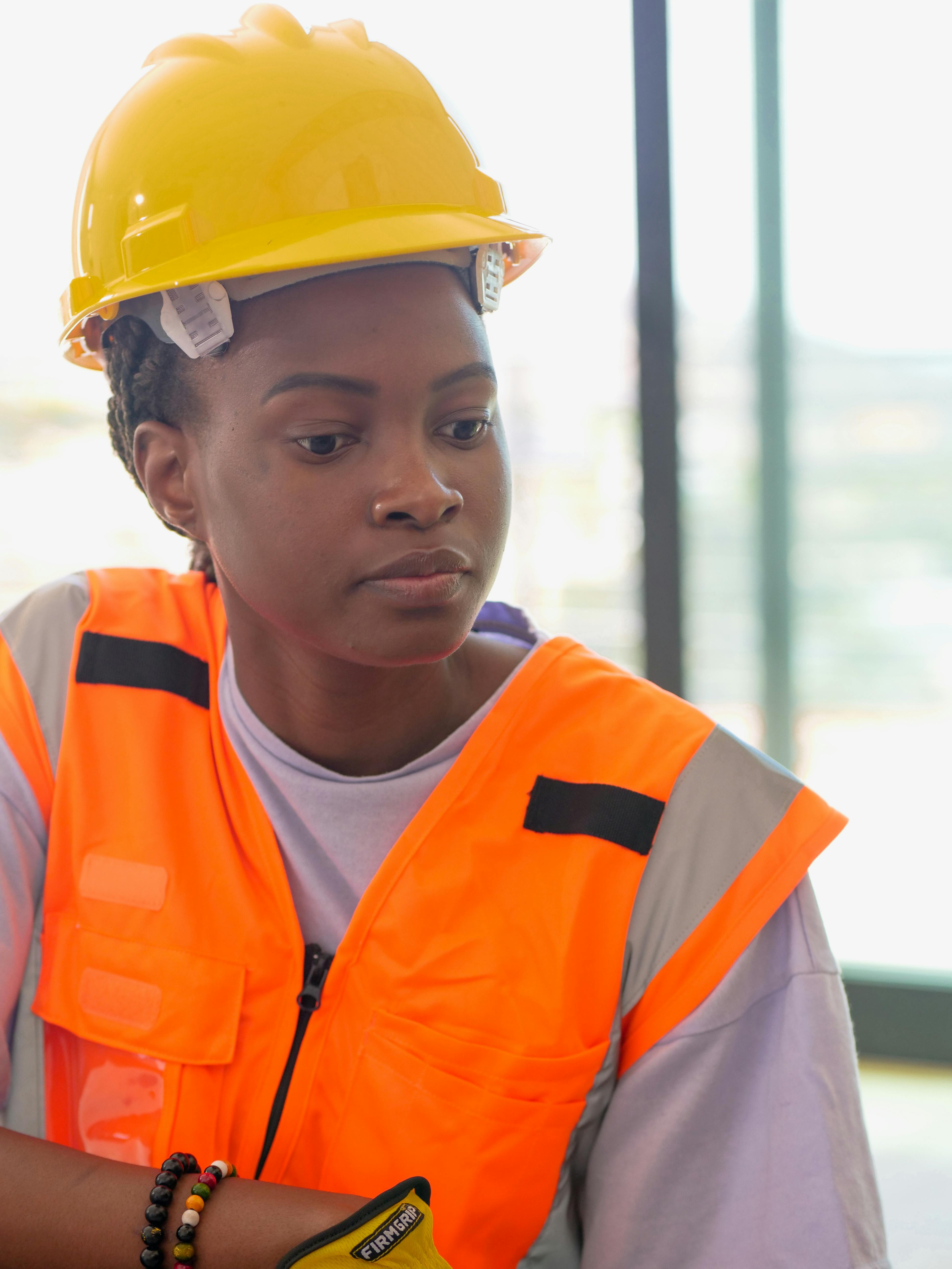 Woman in PPE Pointing Up · Free Stock Photo