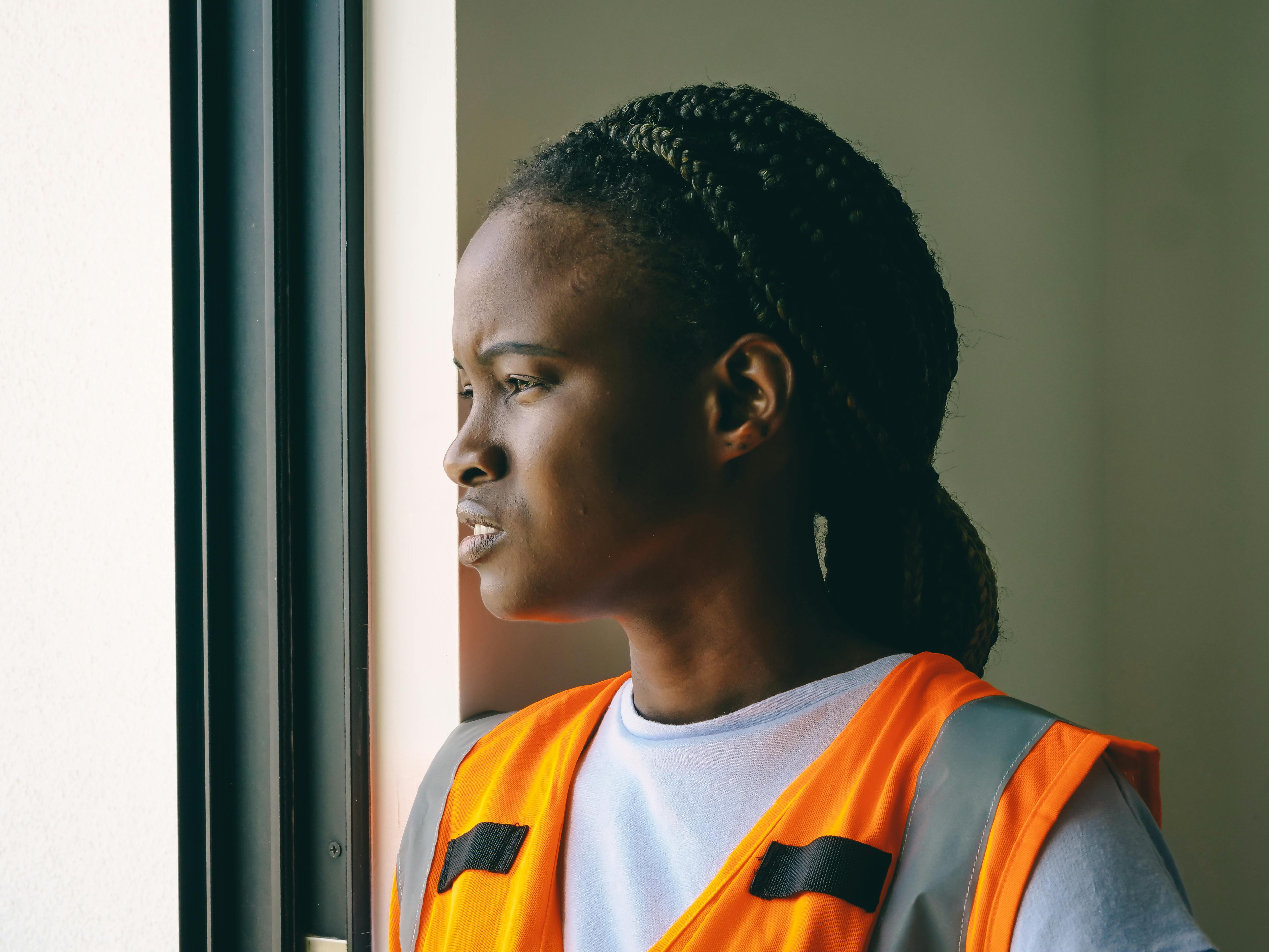 Woman Looking Through a Window Pane · Free Stock Photo