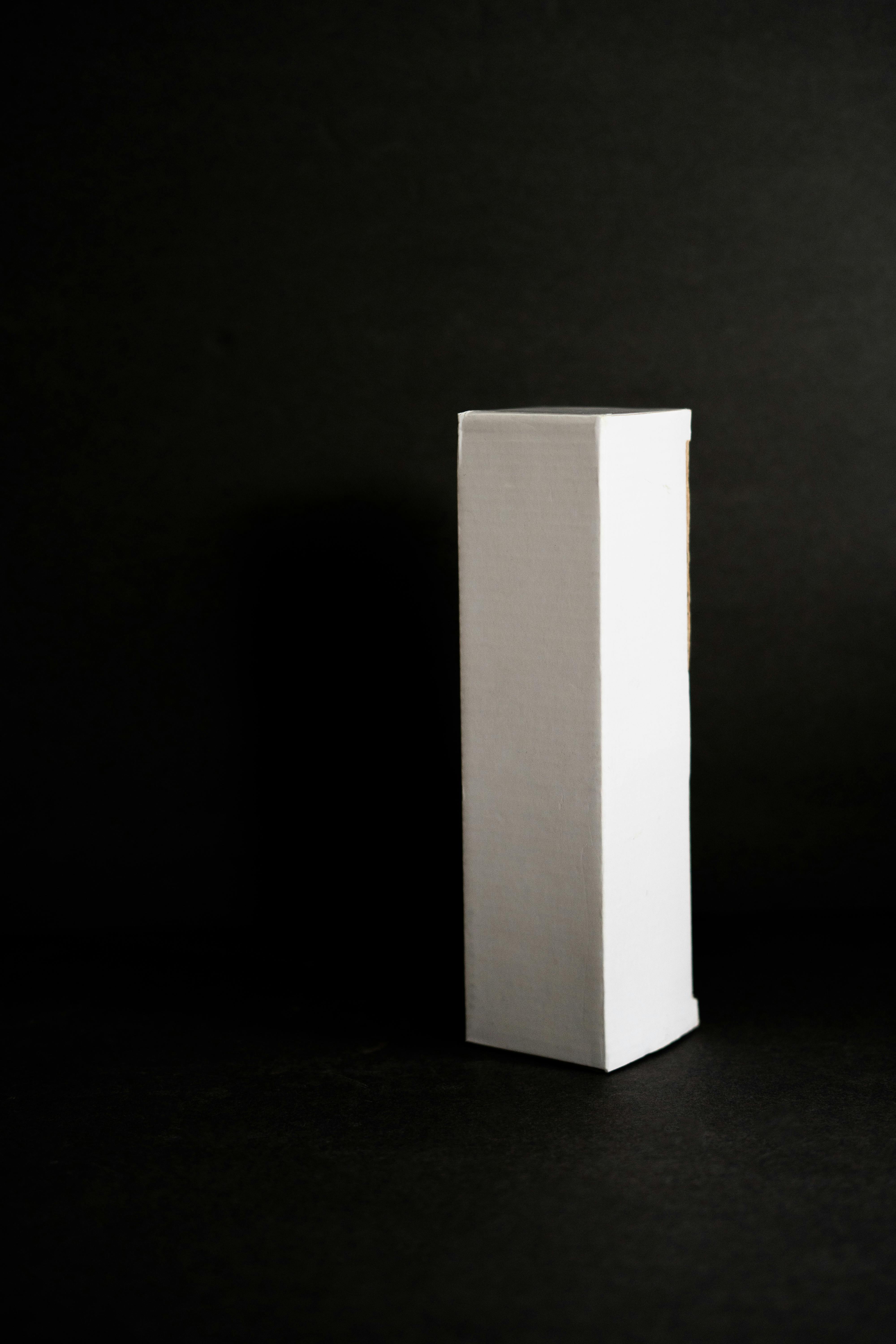 White Rectangular Box on Black Surface · Free Stock Photo