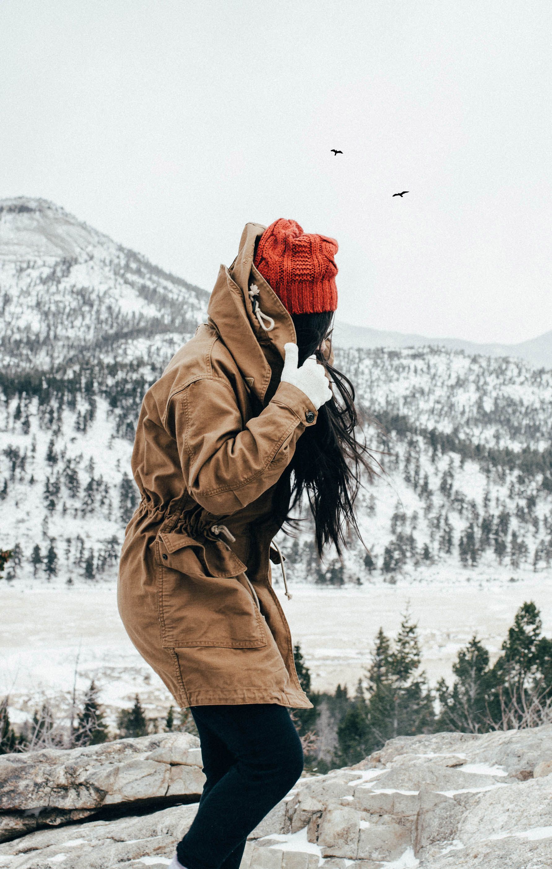 Woman in Brown Jacket Wearing Red Knitted Beanie · Free Stock Photo