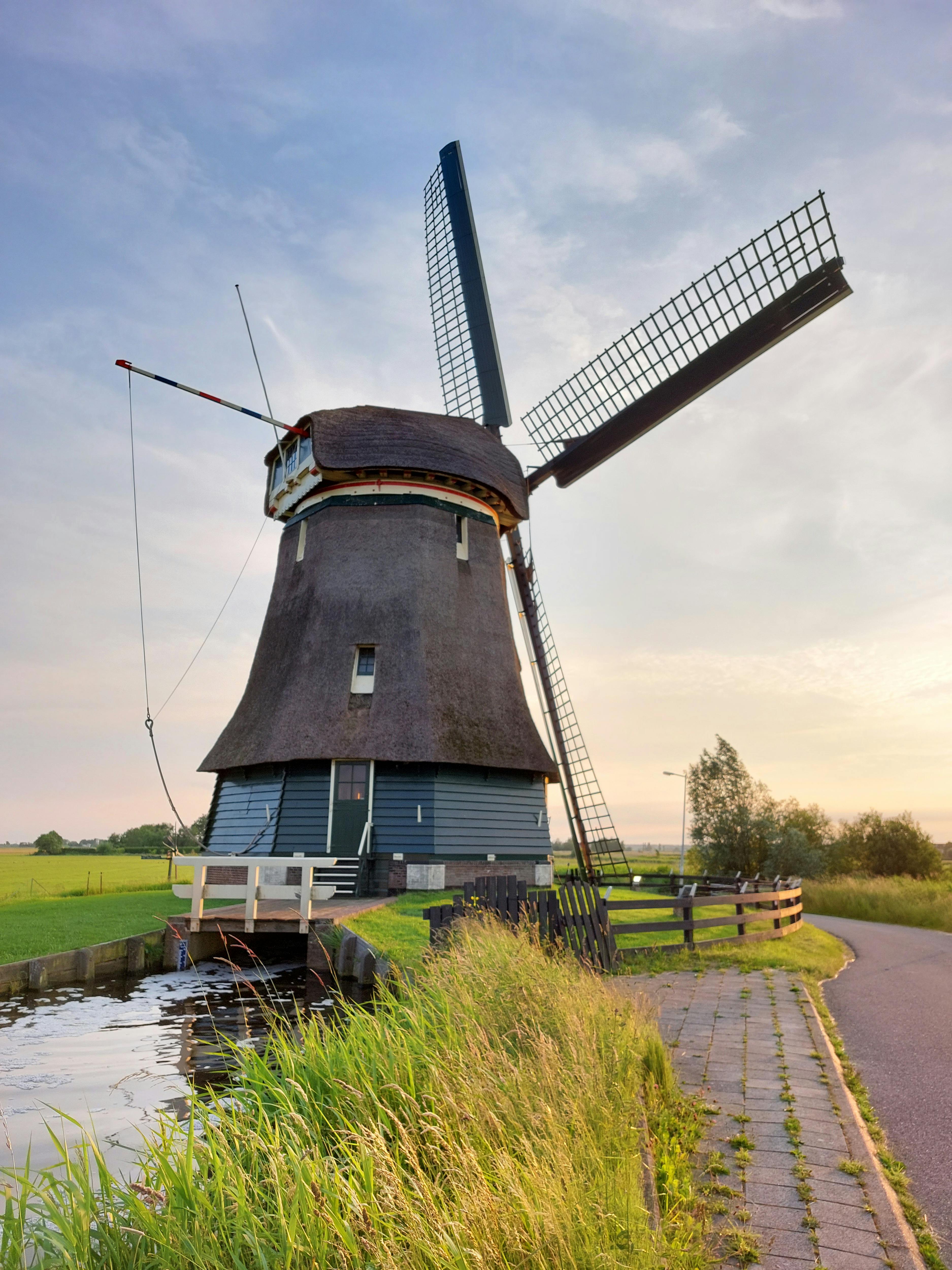 Windmill Near River and Grass Field · Free Stock Photo