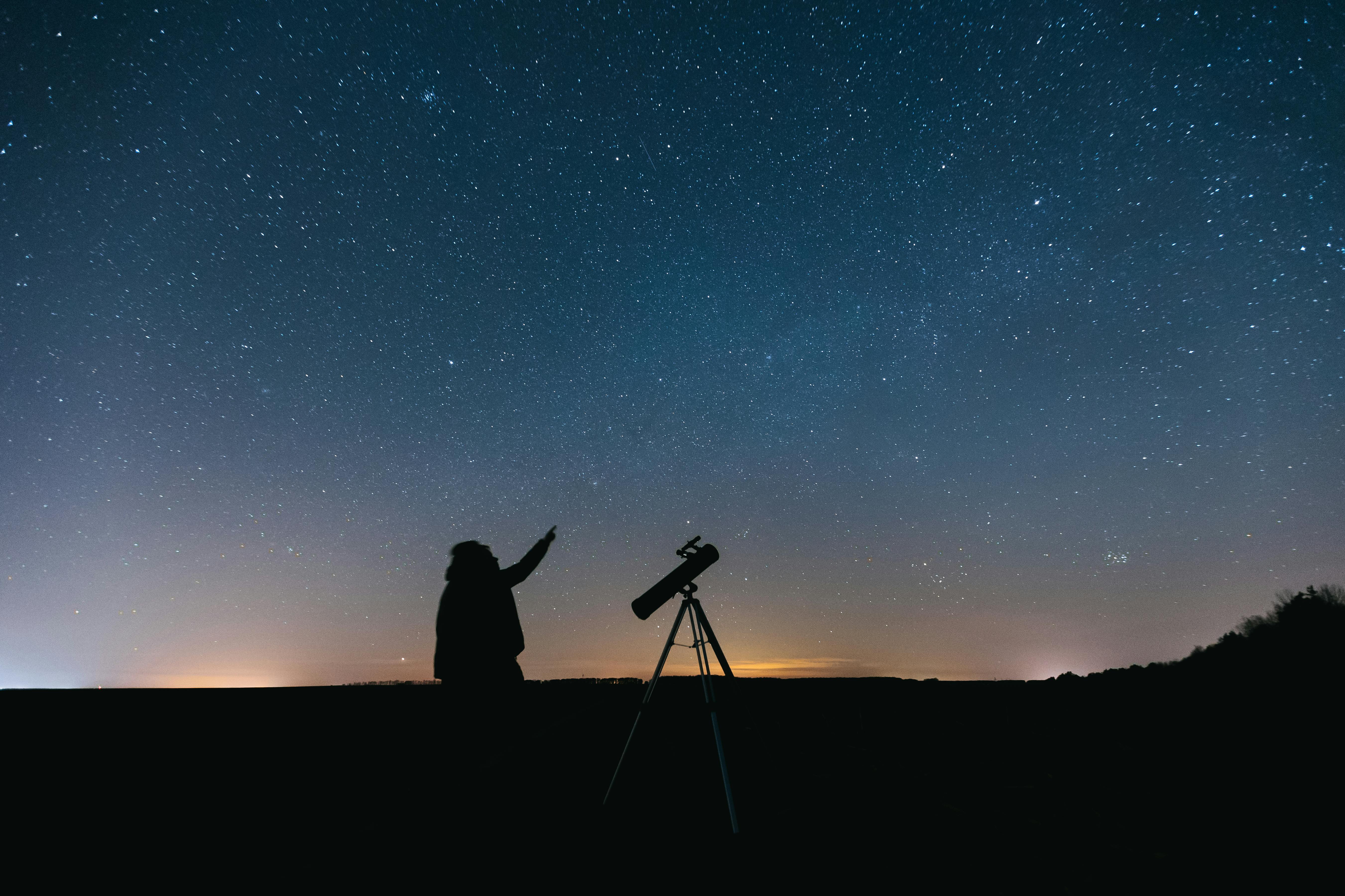 Silhouette of Person Standing Near Telescope · Free Stock Photo