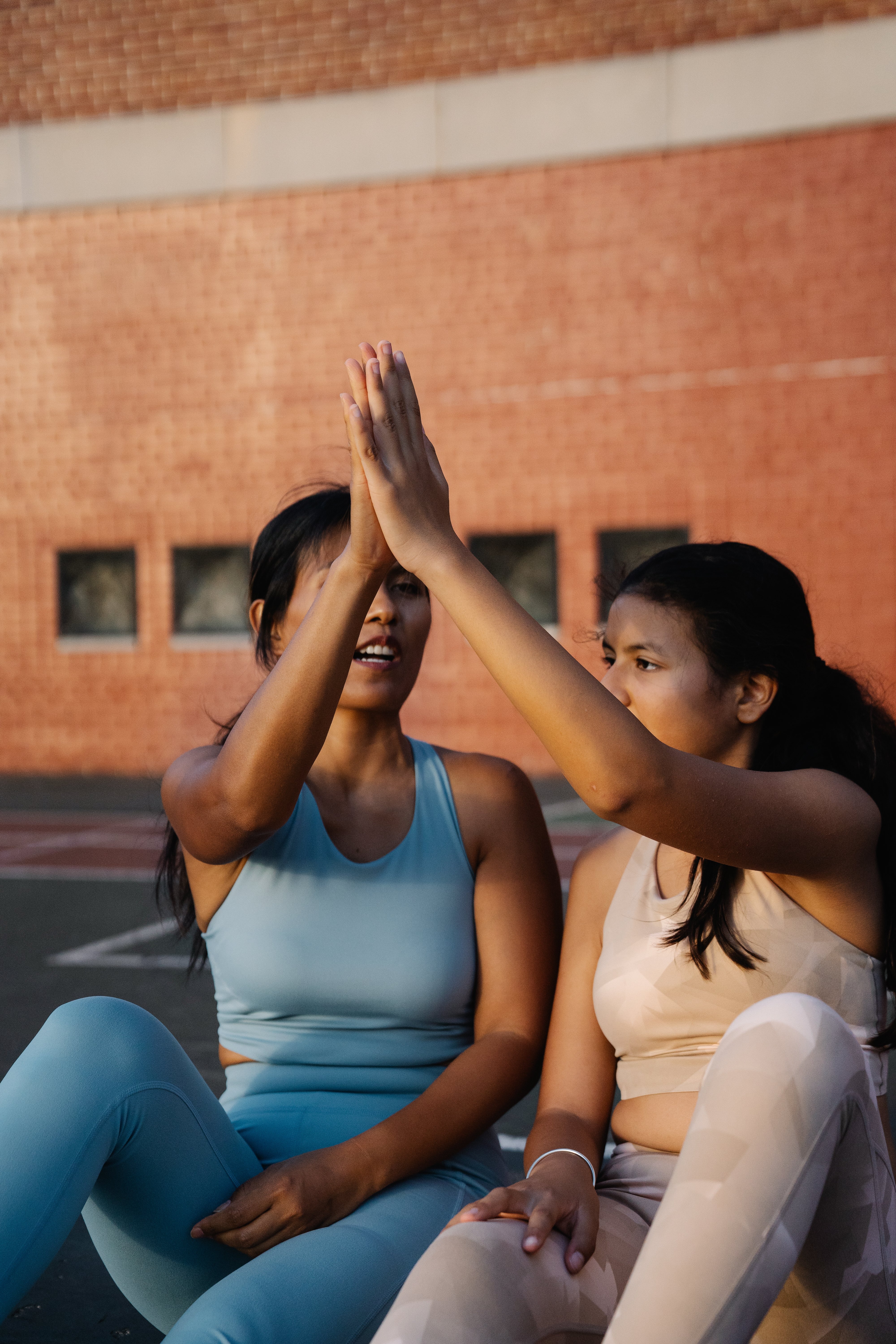 Women in Activewear Doing High Five · Free Stock Photo