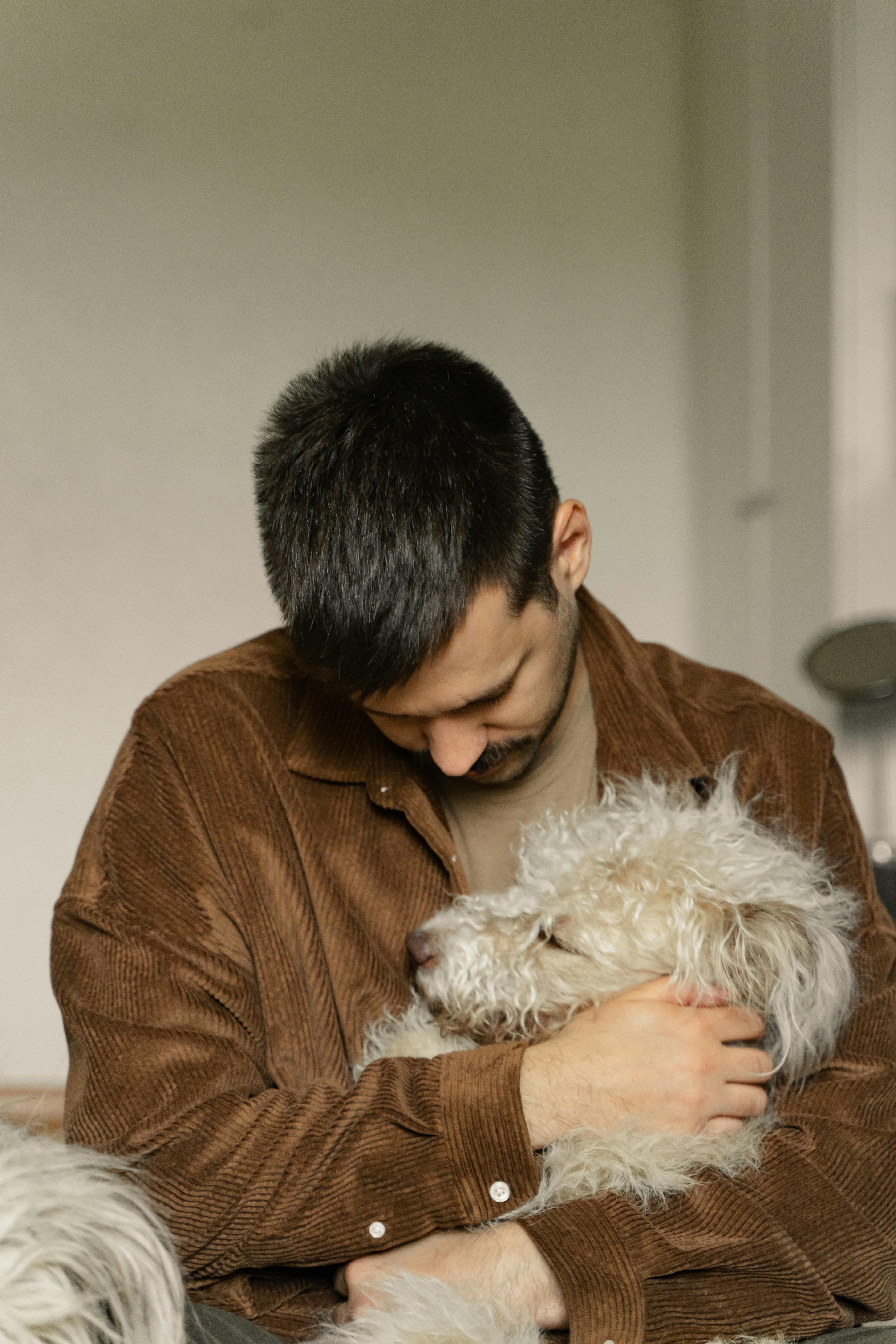 A Man Holding a Dog · Free Stock Photo