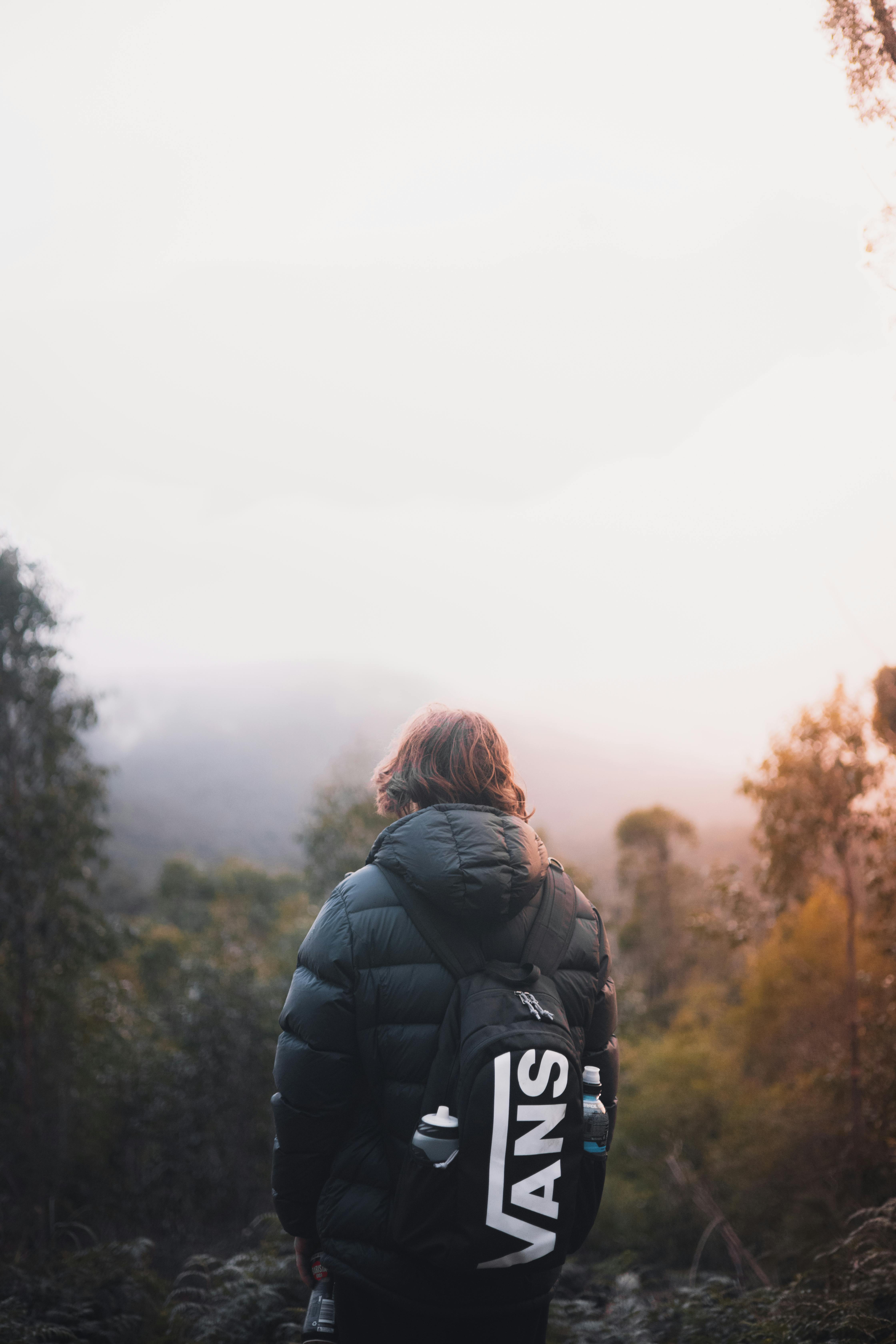 Back View of a Person in Black Winter Jacket Carrying Backpack · Free ...