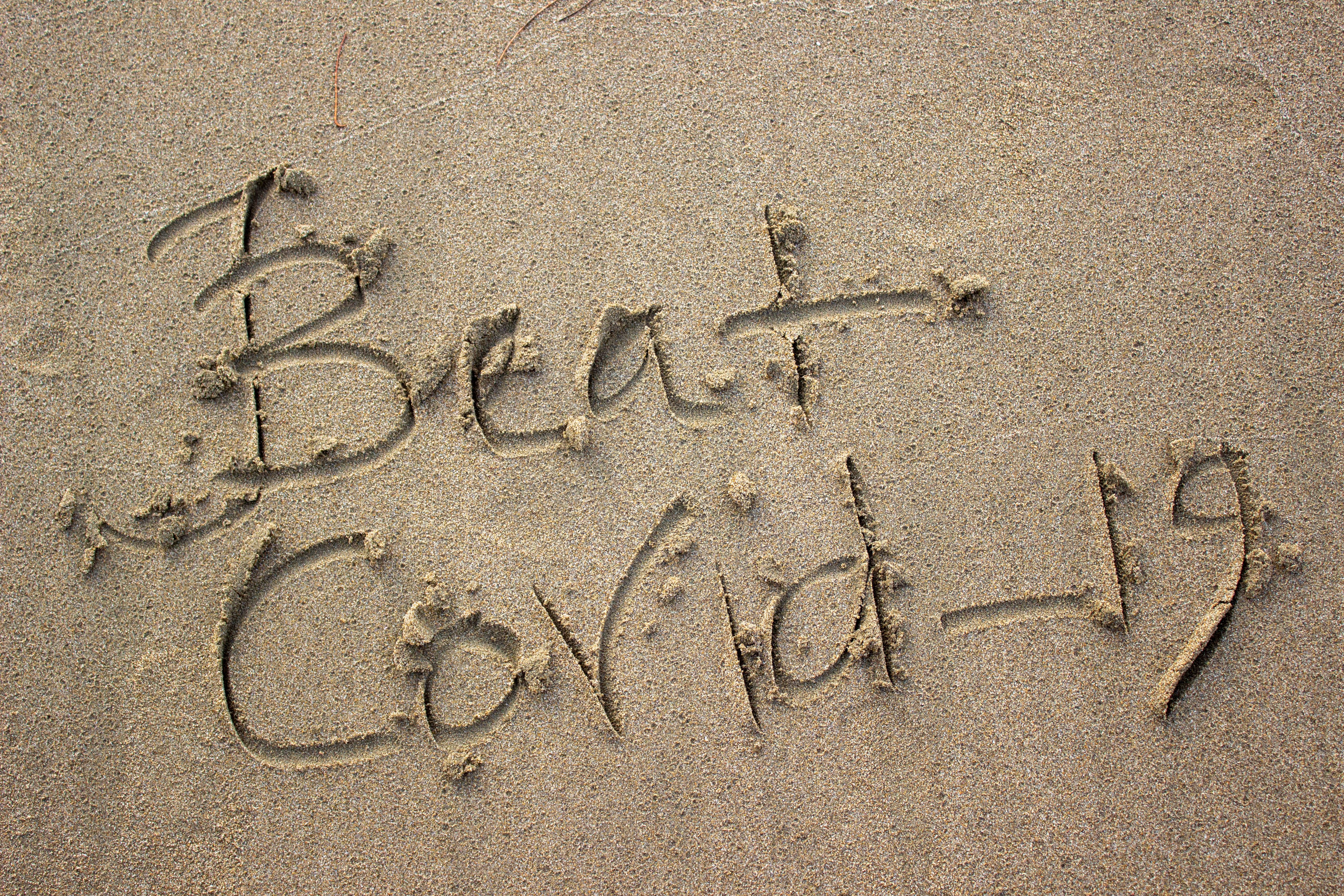 Message Written on Brown Beach Sand · Free Stock Photo