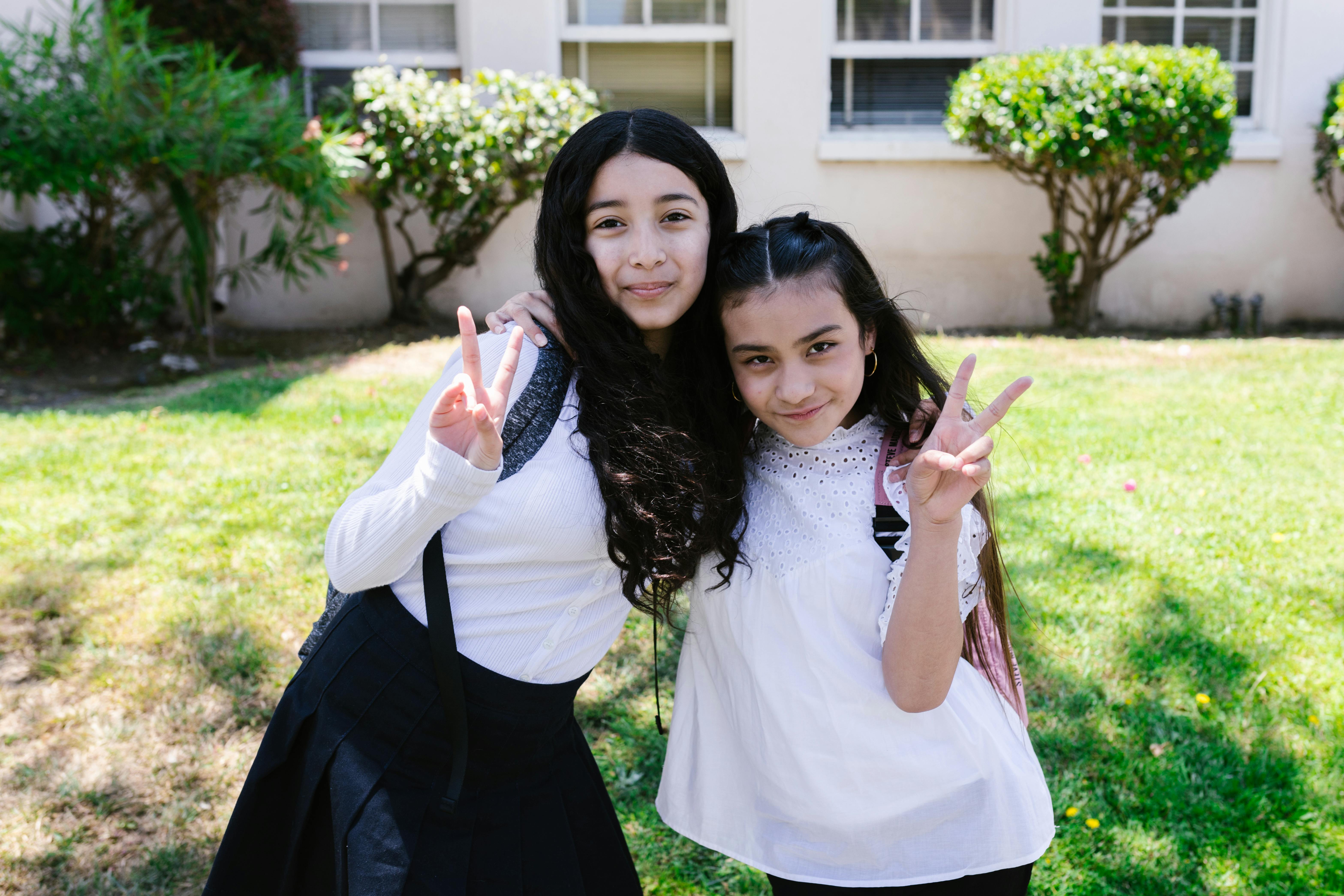 Girls Doing a Peace Sign · Free Stock Photo